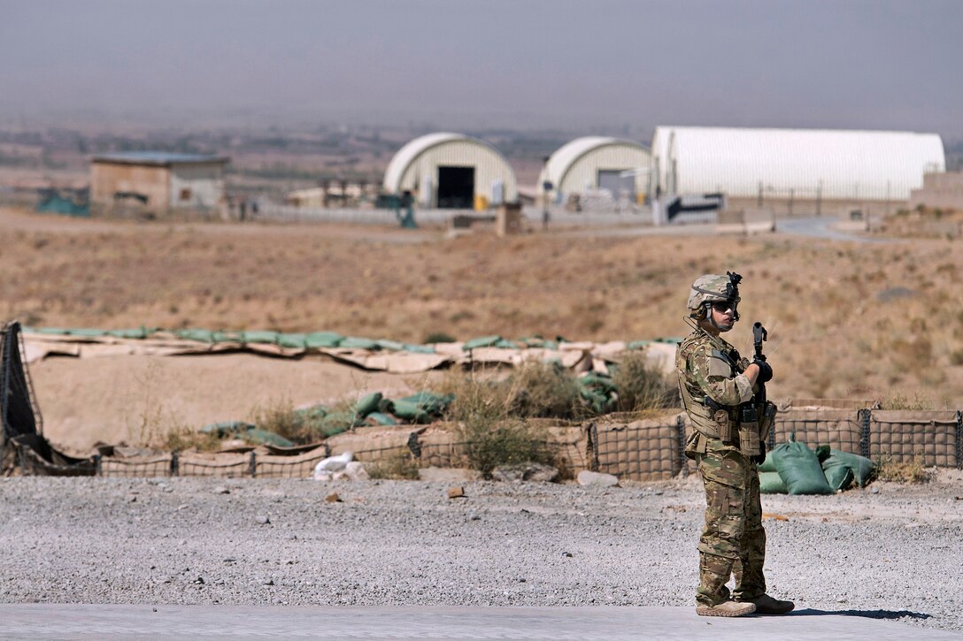 U.S. Air Force Staff Sgt. Juan Pareja provides security as C-130 ...