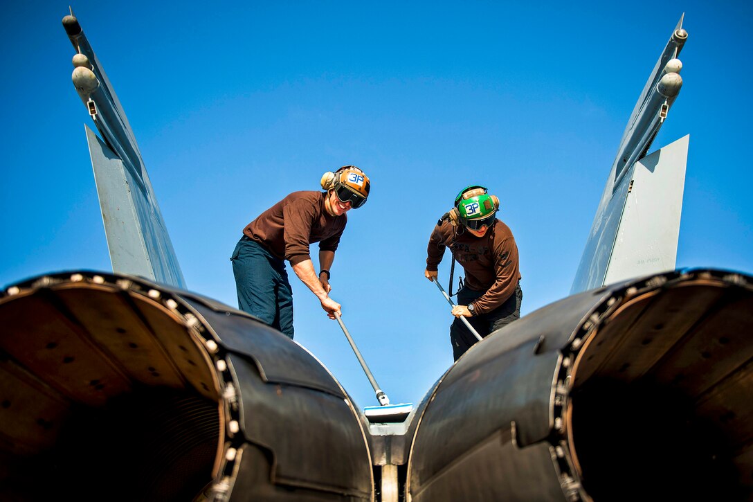 U.S. Navy Petty Officers 3rd Class Brandon Shreve, left, and U.S. Navy ...