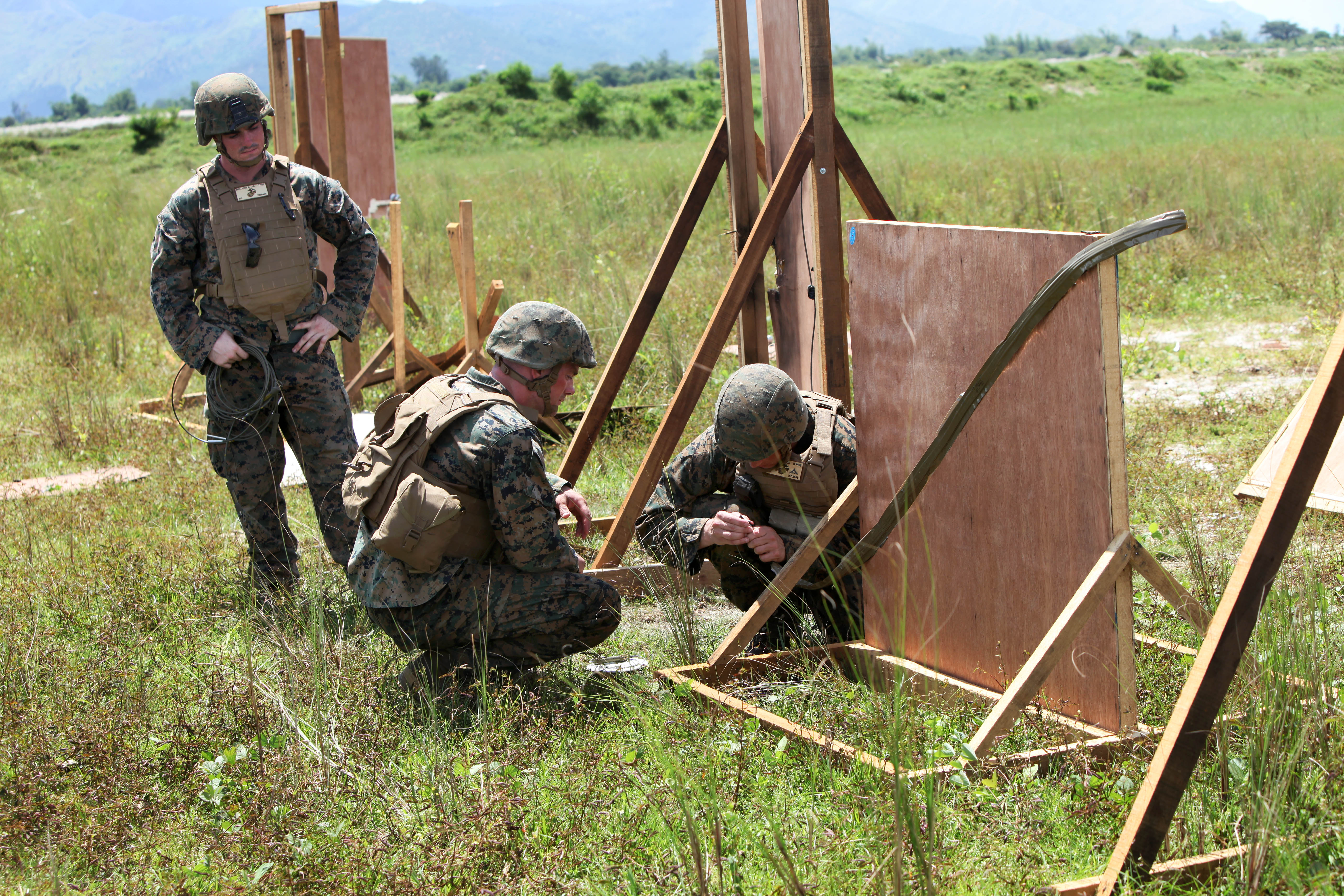 U.S. Marines set a linear charge to a obstacle during Amphibious ...
