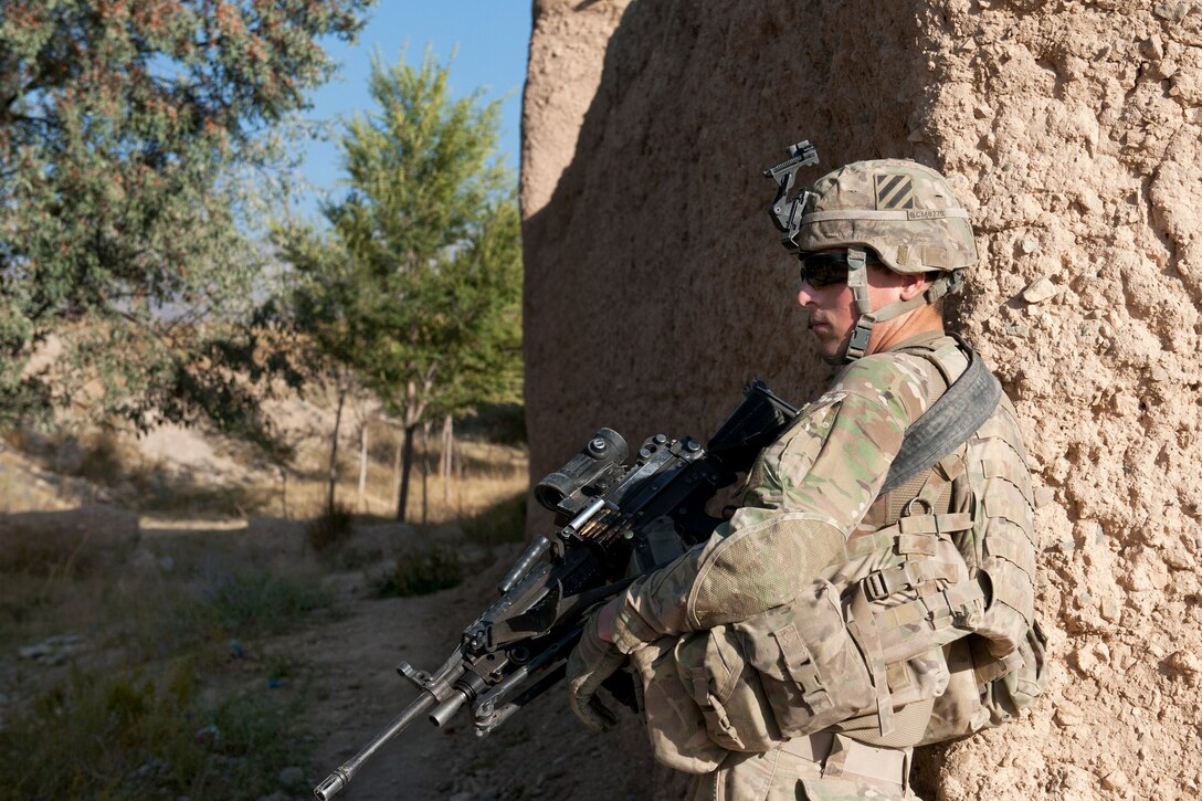 U.S. Army Pfc. Cooper Martin provides security during a presence patrol ...