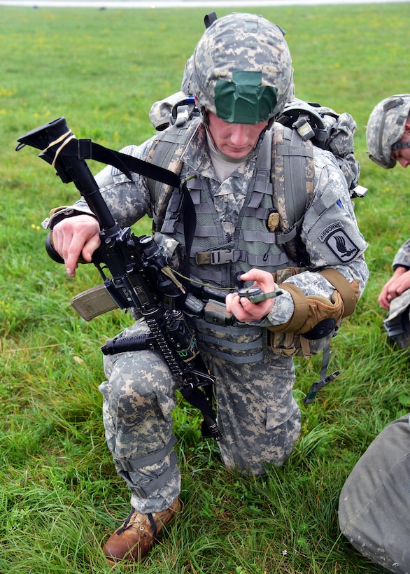A U.S. Army paratrooper checks his compass during a training mission on ...