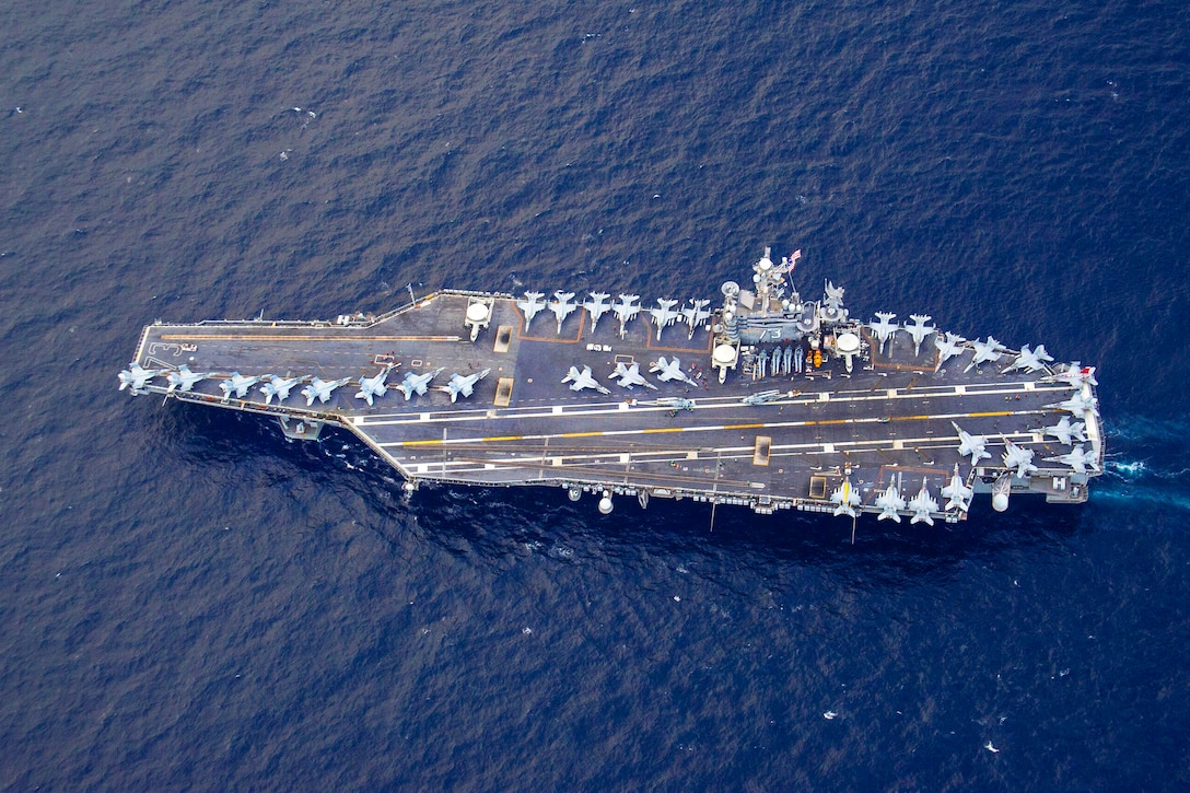 The aircraft carrier USS George Washington patrols the waters west of ...