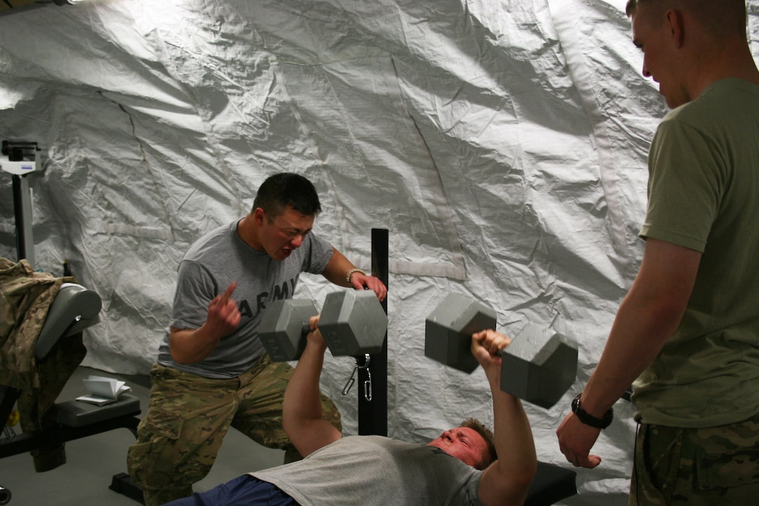 Army Sgt. John Hess jokingly encourages Army Spc. Nathaniel Gooding ...