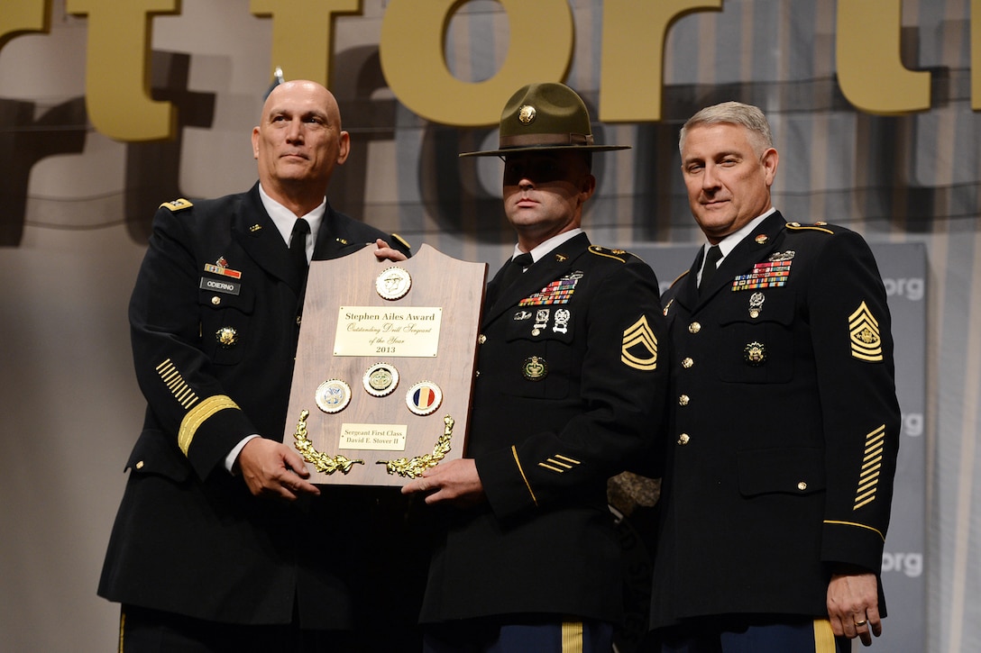 Army Sgt. 1st Class David Stover II, center, accepts the Stephen Ailes ...