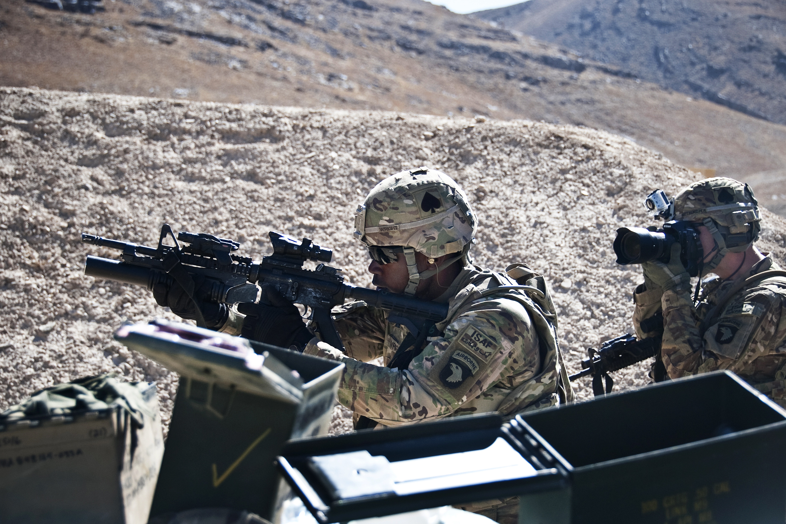 U.S. Army Pfc. Rohan Wright, left, prepares to fire an M203 grenade ...
