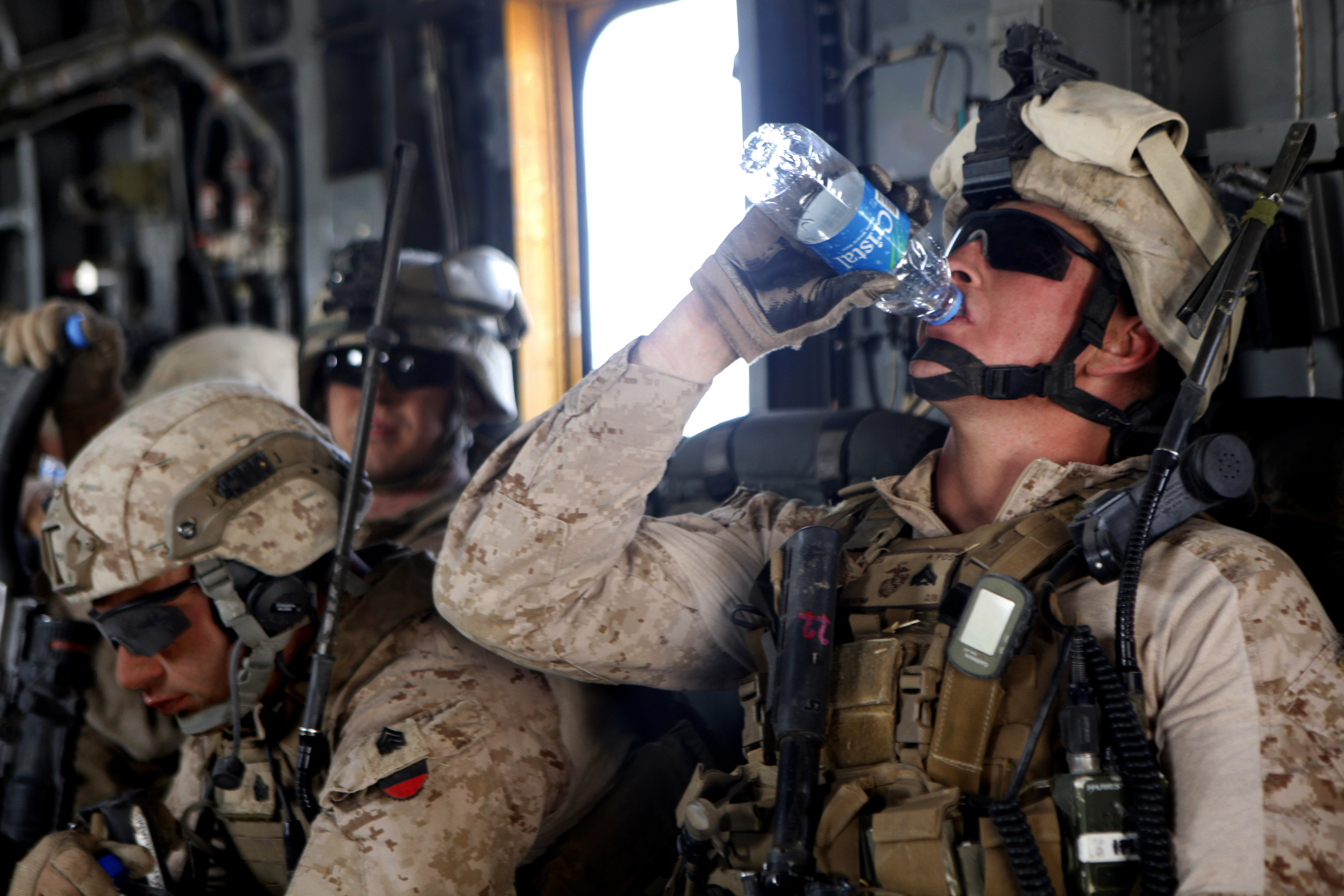U.S. Marine Corps Cpl. Cody M. Pierce, right, drinks water inside a CH ...