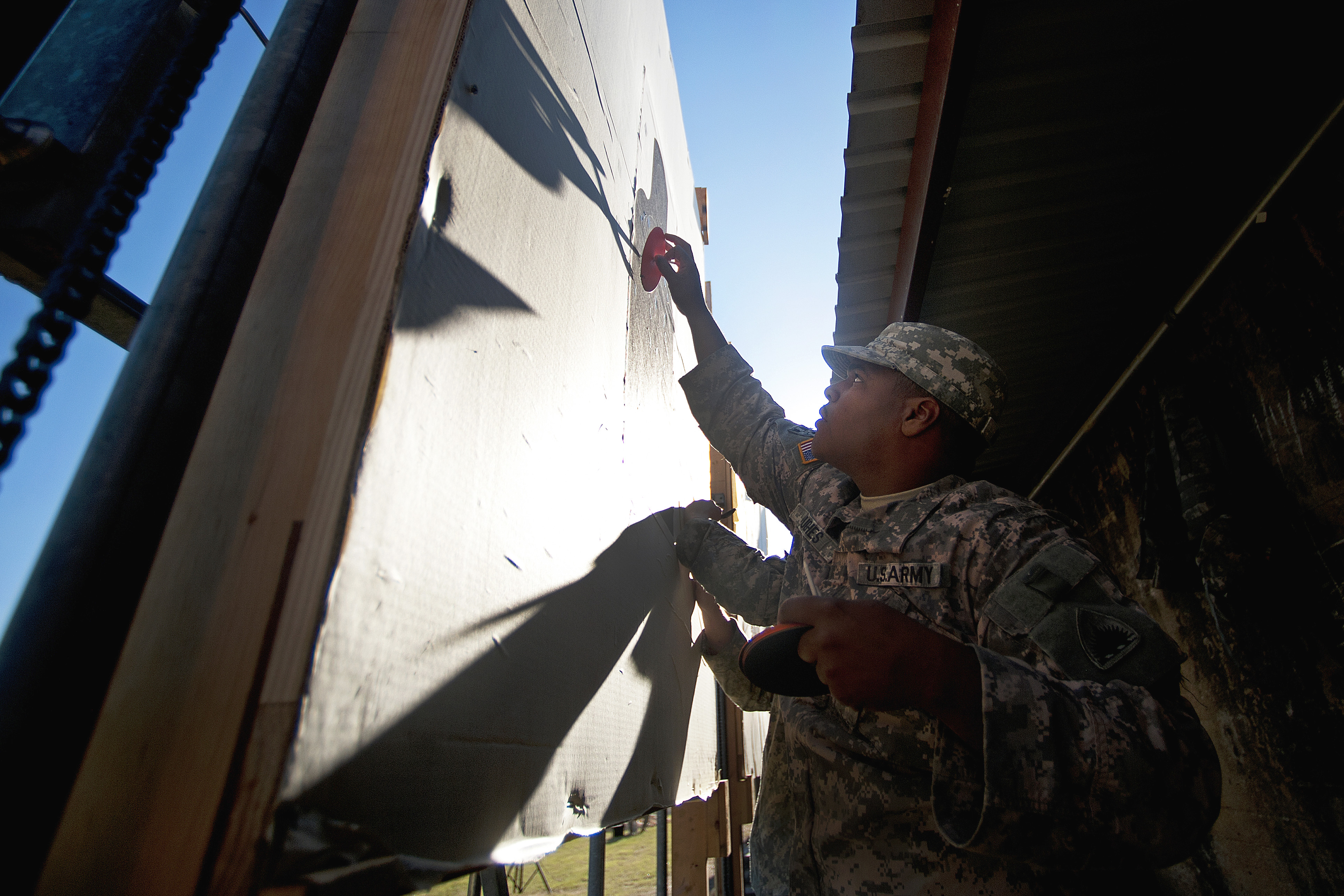 Army Sgt. Roger Hughes marks hits on a target during the Winston P ...