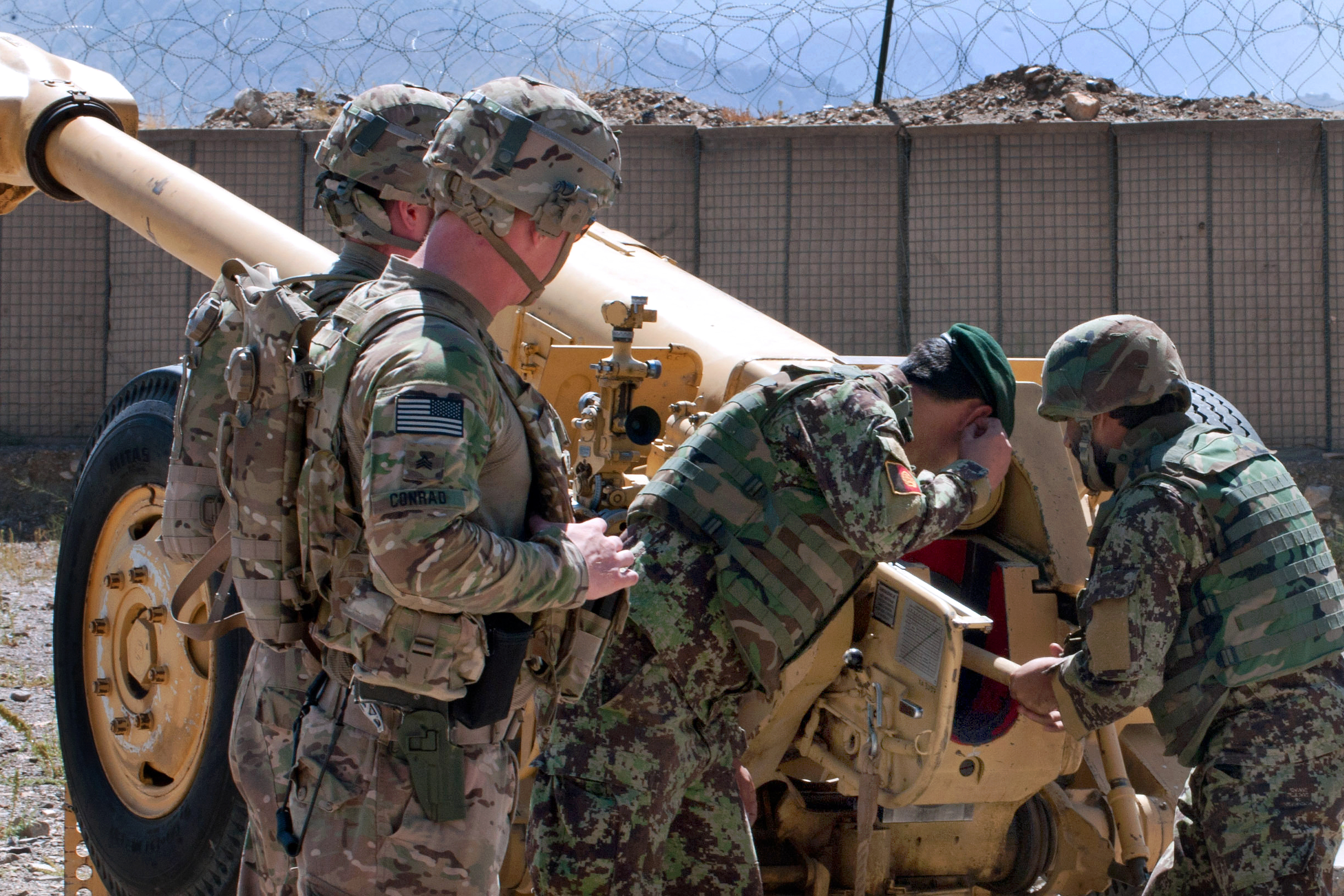 U.S. Army Sgt. Matthew Conrad, right, observe as Afghan soldiers load a ...