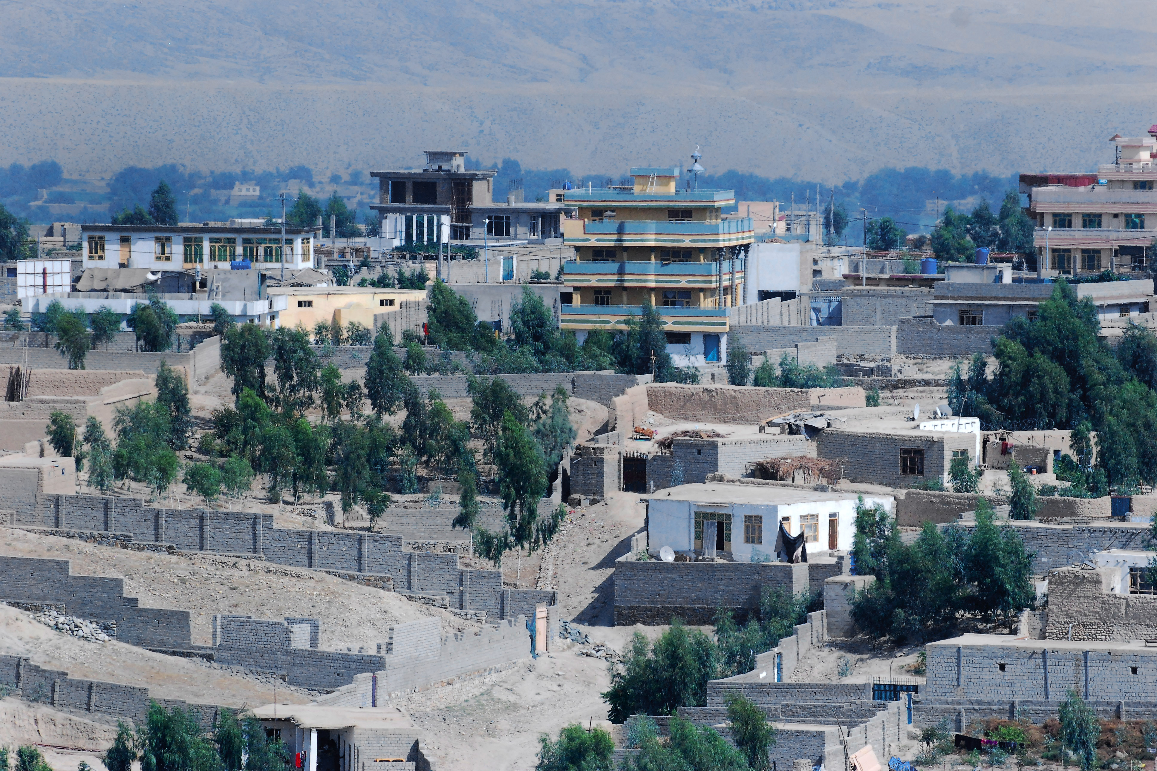 The side door window of a UH-60 Black Hawk helicopter shows a view of ...