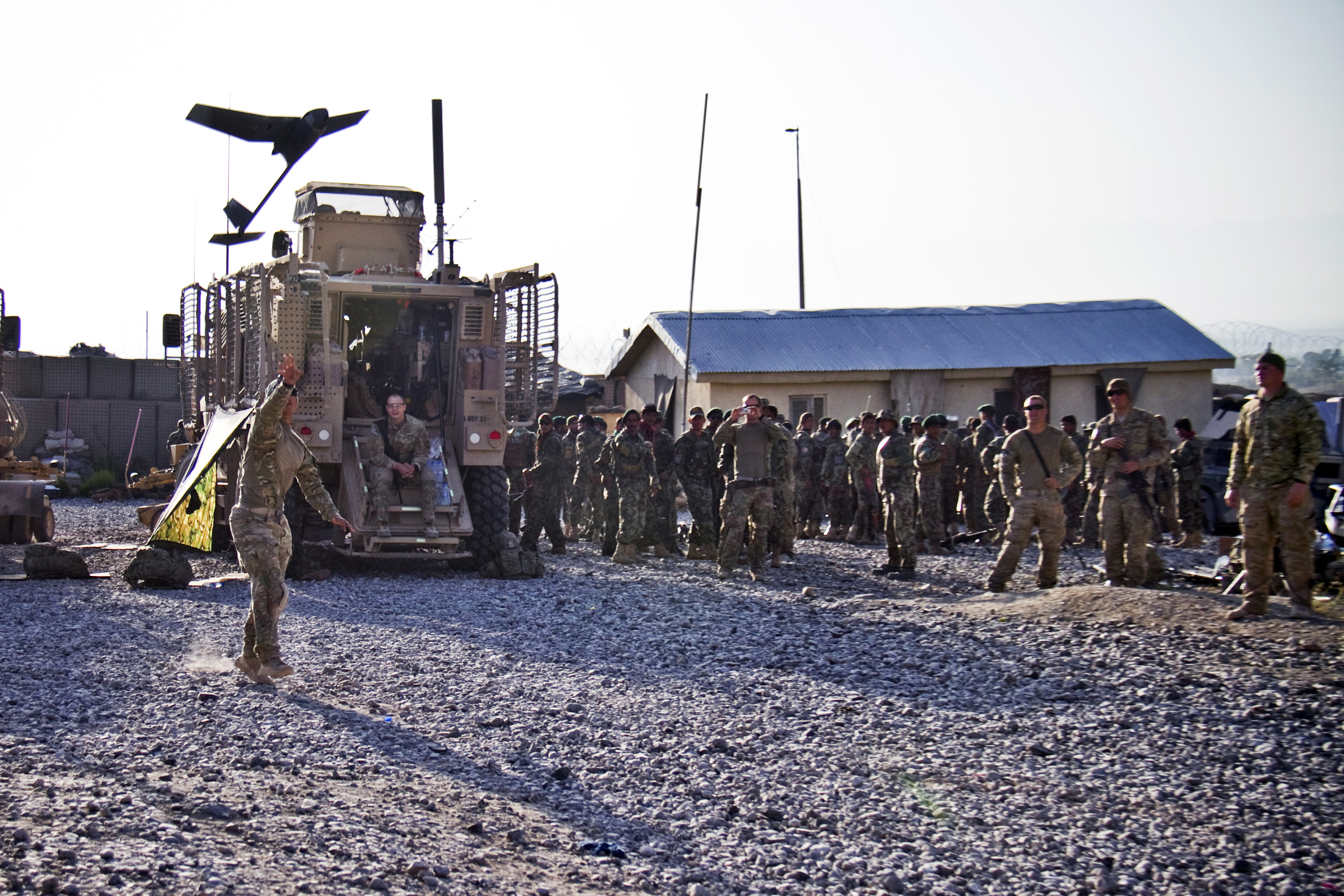 U.S. Army Spc. Charles R. Reiff launches an RQ-11 Raven unmanned aerial ...