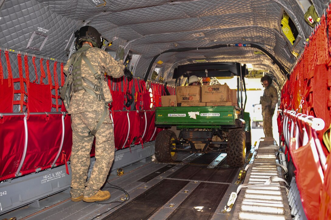 Army Pvt. Ben Stocker, left, and Army Staff Sgt. Guy Morgan guide and ...