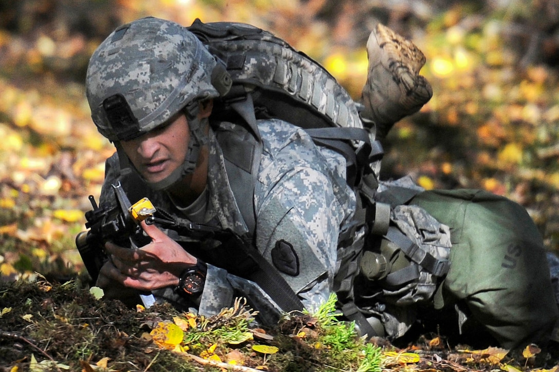 Army Spc. Adrian Castillo reacts to direct enemy fire and throws himself to the ground during ...