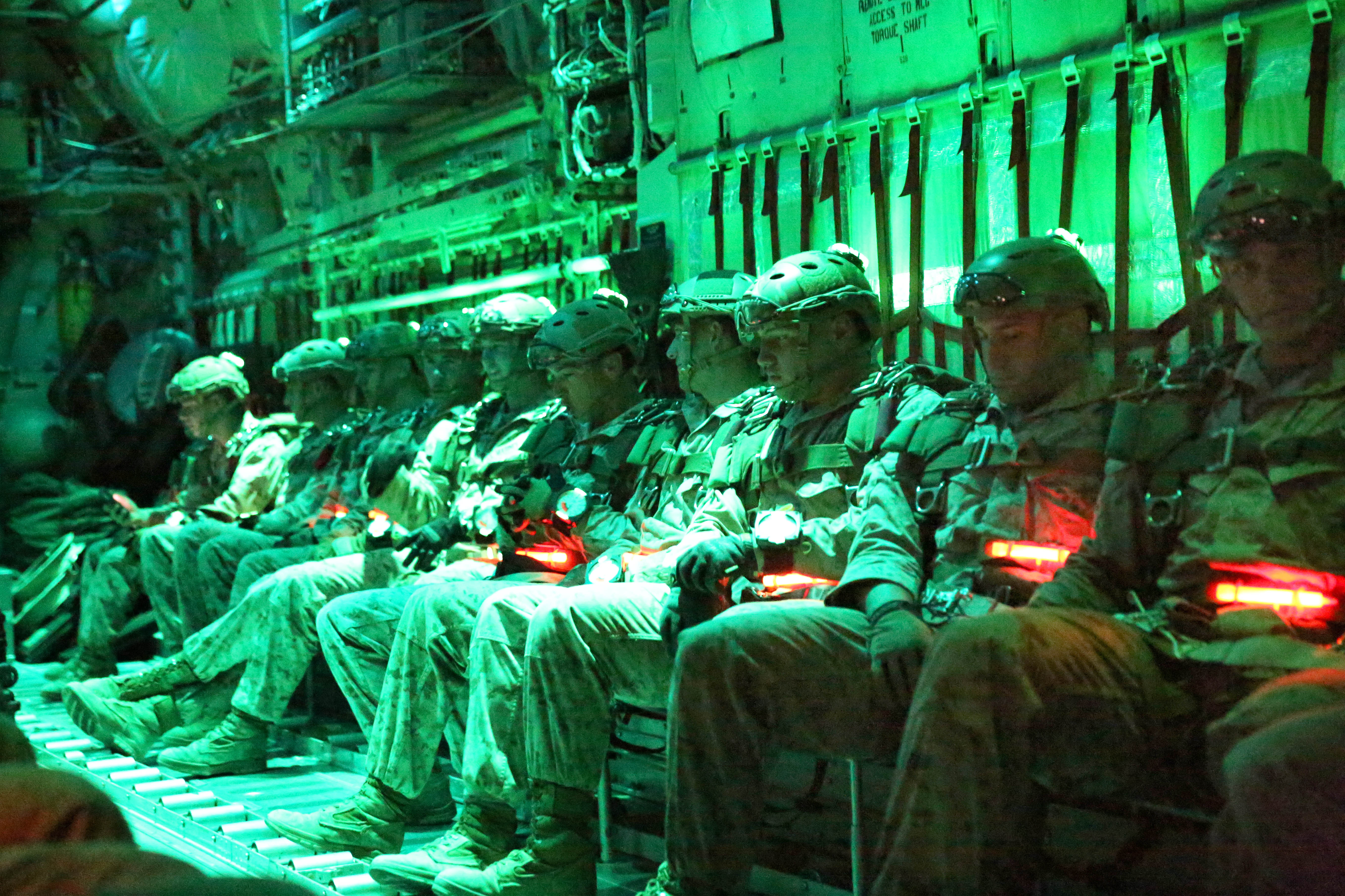 Marines sit in a C-130 Hercules aircraft waiting for the command to ...