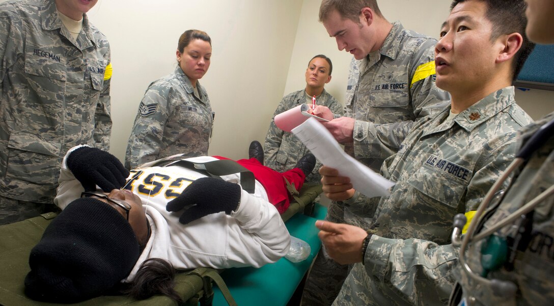 Air Force Maj. (Dr.) Roger Shih, right, discusses emergency patient ...