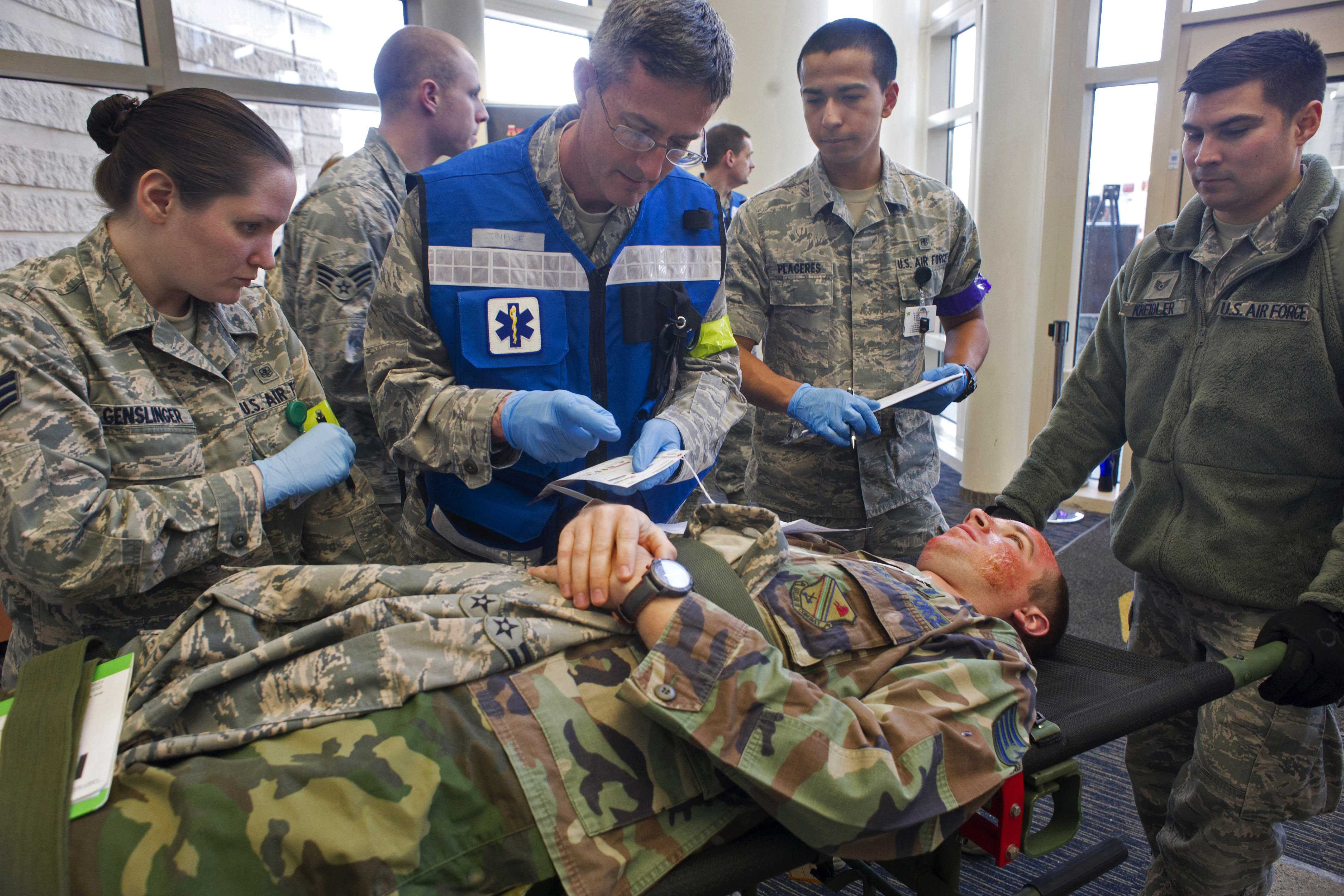 Air Force Lt. Col. (Dr.) Michael Michener, center, evaluates a ...
