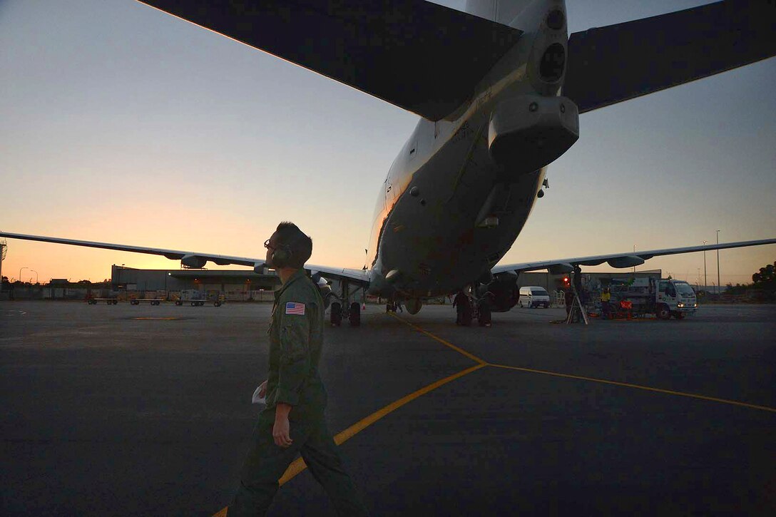 U.S. Navy Petty Officer 3rd Class Michael Herman inspects a P-8A ...