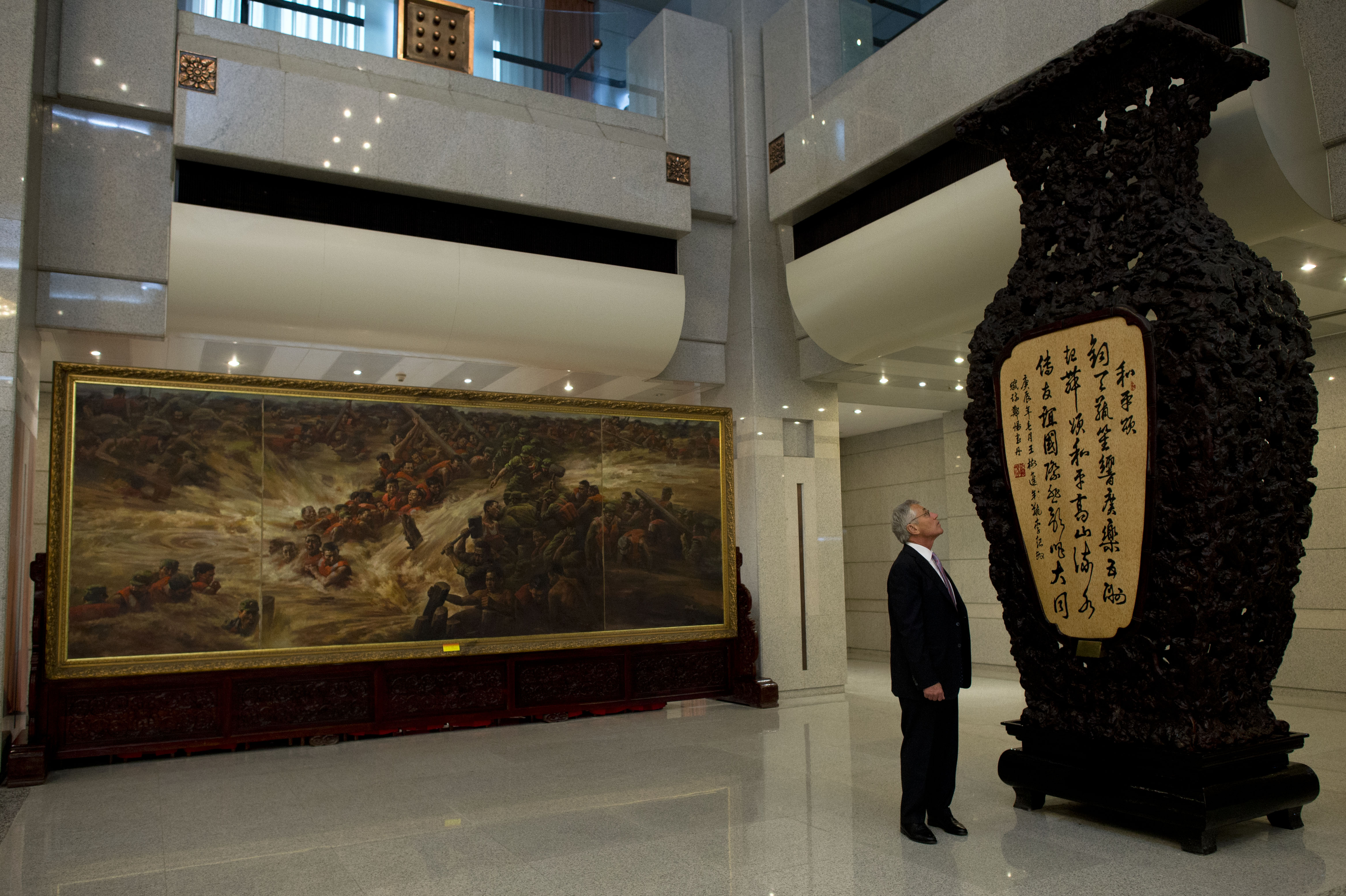 U.S. Defense Secretary Chuck Hagel looks at artwork at the Bayi ...