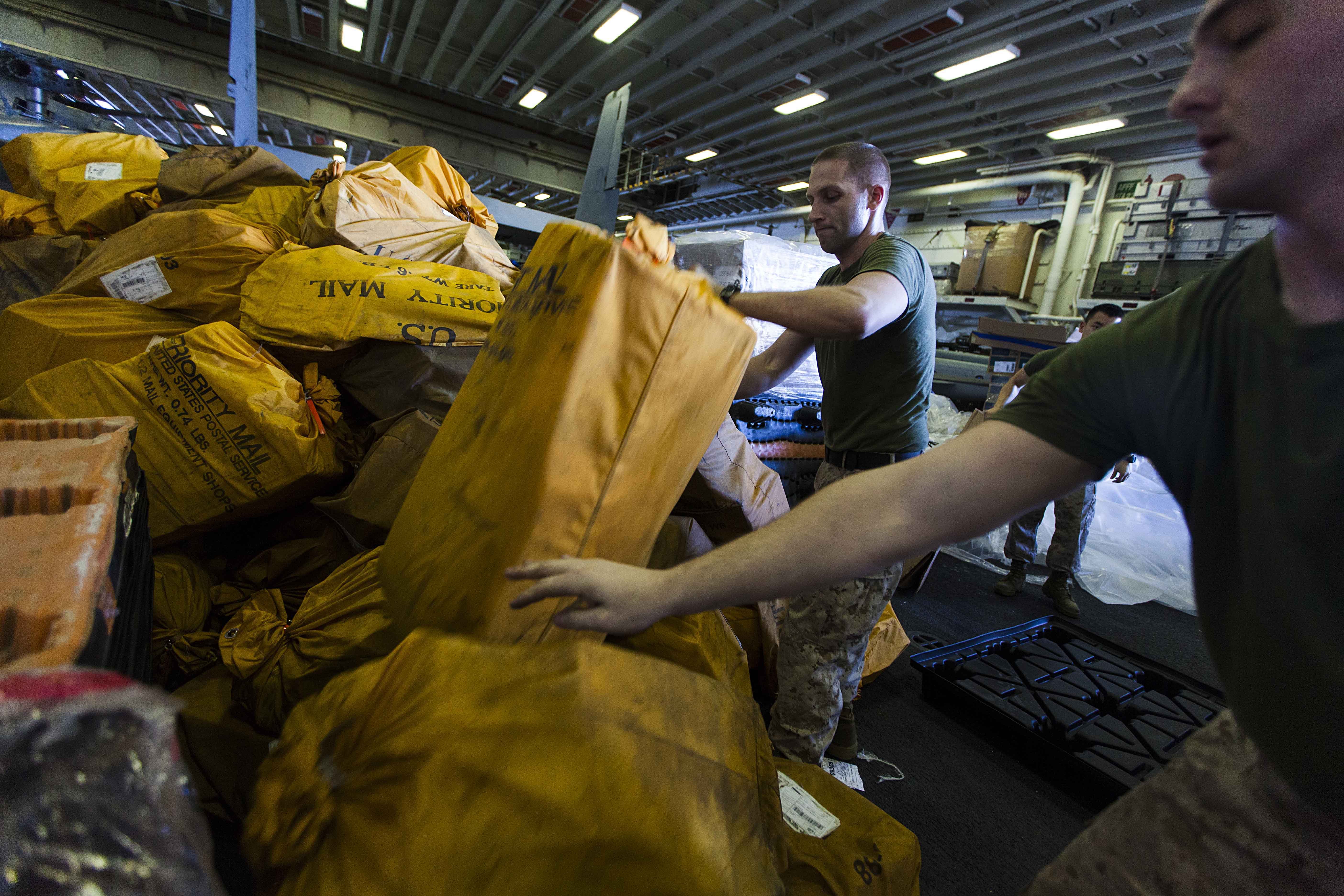 Marines and Sailors receive two tons of mail aboard the Bataan