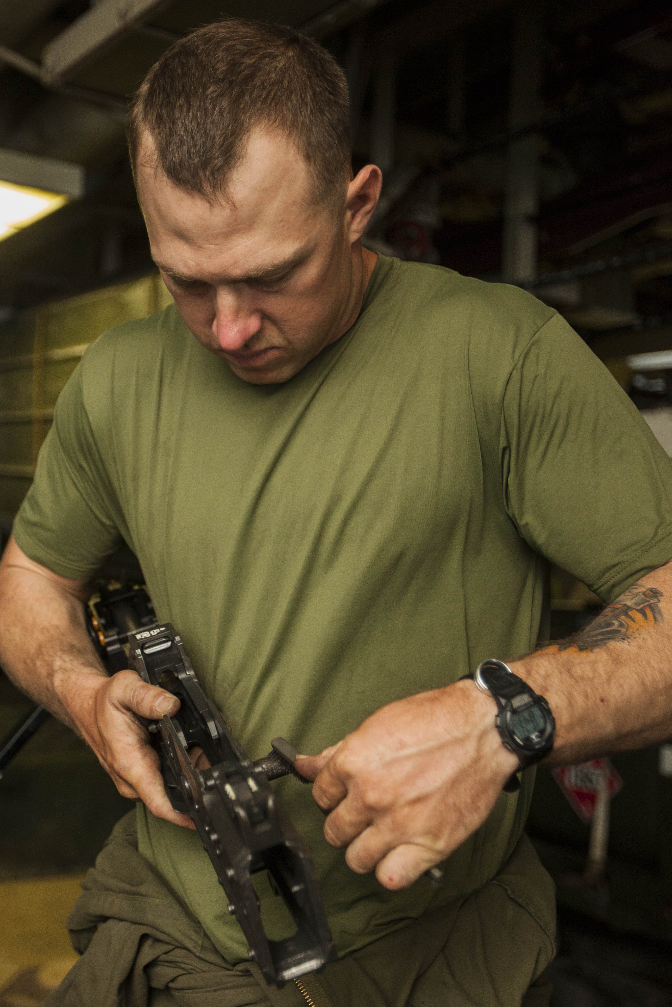 LAR Marines clean machine guns aboard USS Bataan