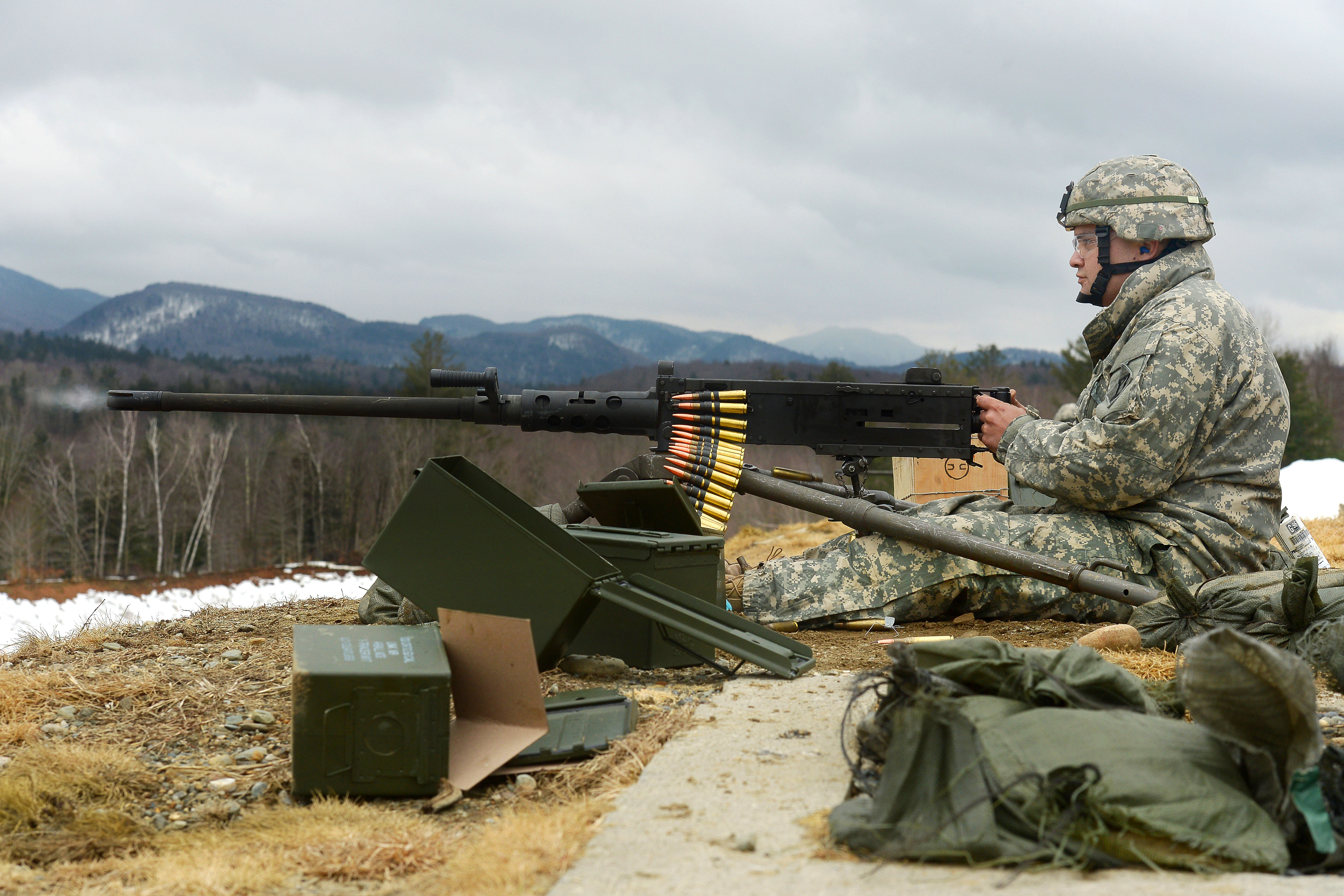 Army Spc. Raynie Perez test fires a tripod-mounted M2A1 machine gun ...