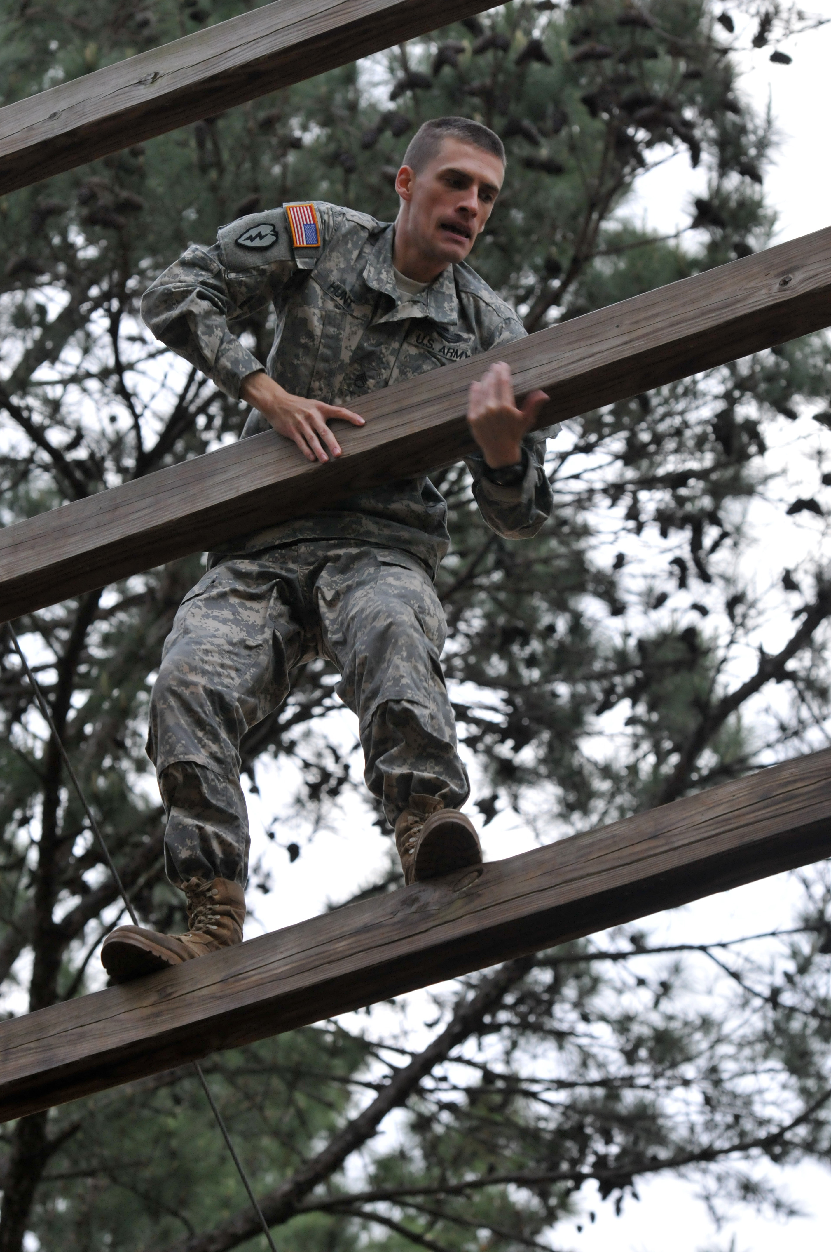 Army Staff Sgt. Eric N. Hunt climbs a wooden ladder during the obstacle ...