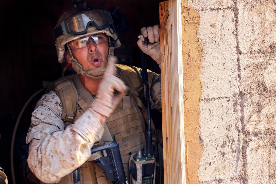 Marine Corps Staff Sgt. Damian Chacon signals to his squad on Yuma ...