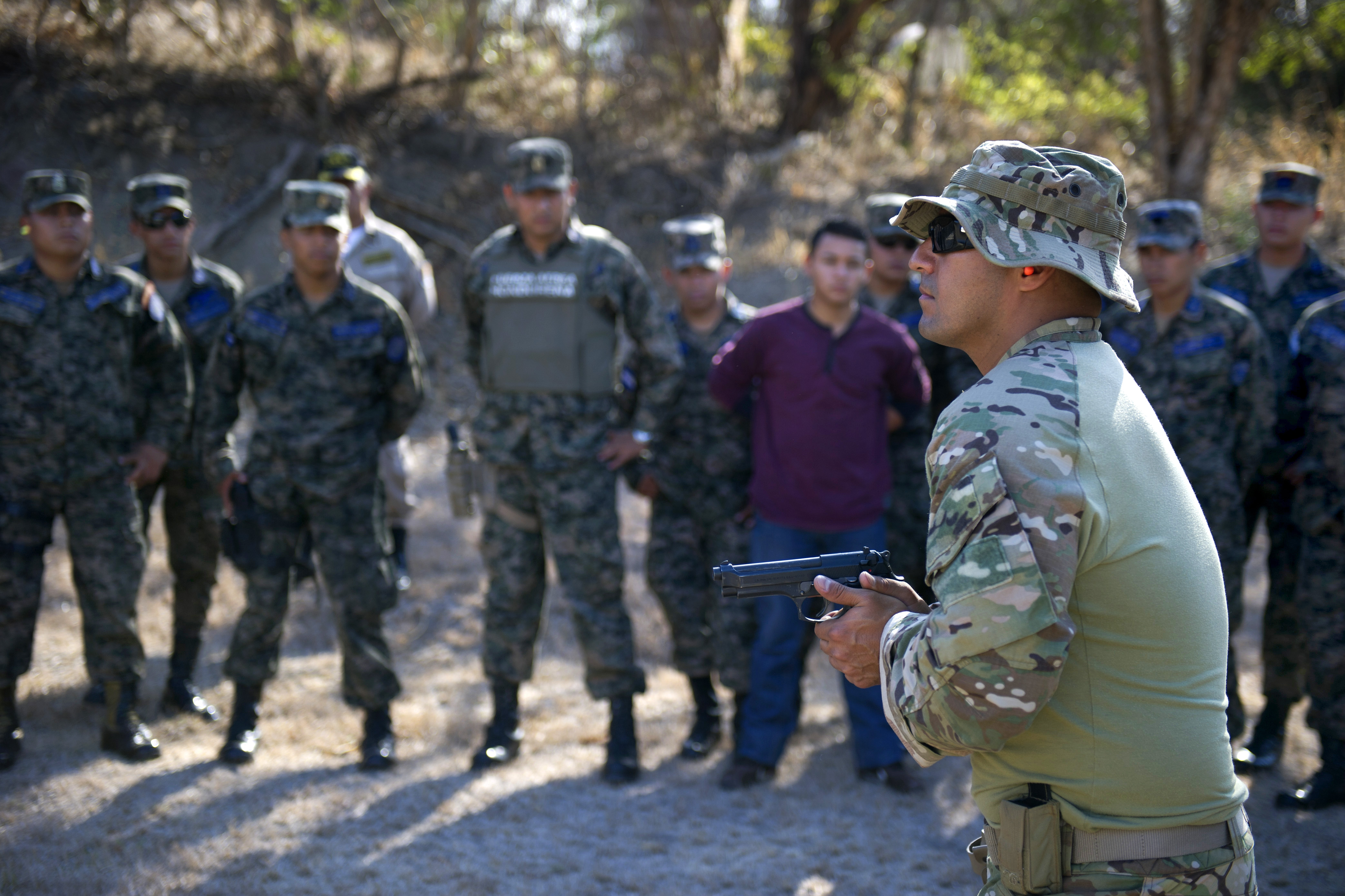 A U.S. Special Forces soldier, foreground, demonstrates how to hold an ...