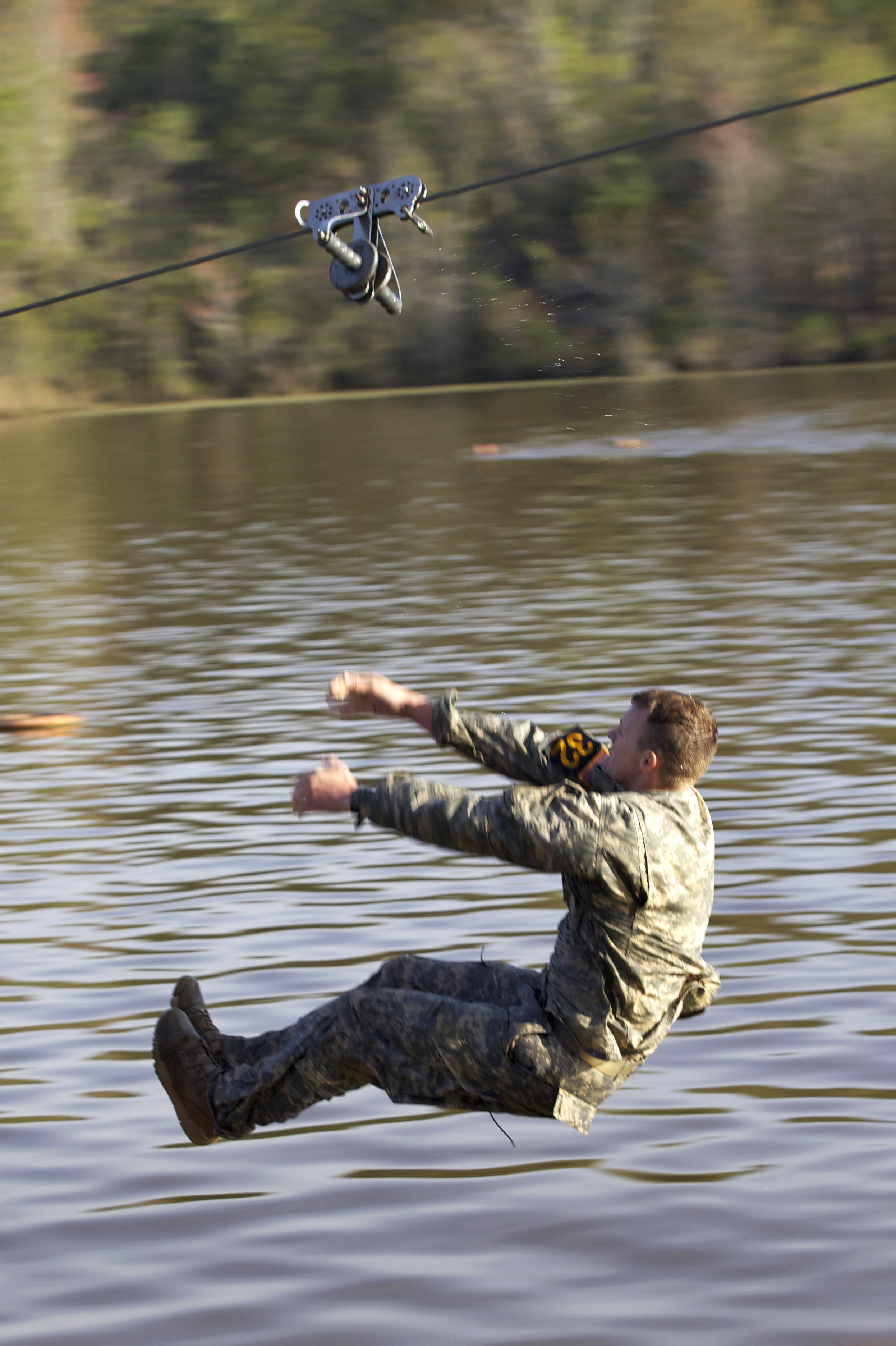 Army 1st Lt. Nicholas Plocar drops into a pond on Fort Benning, Ga ...
