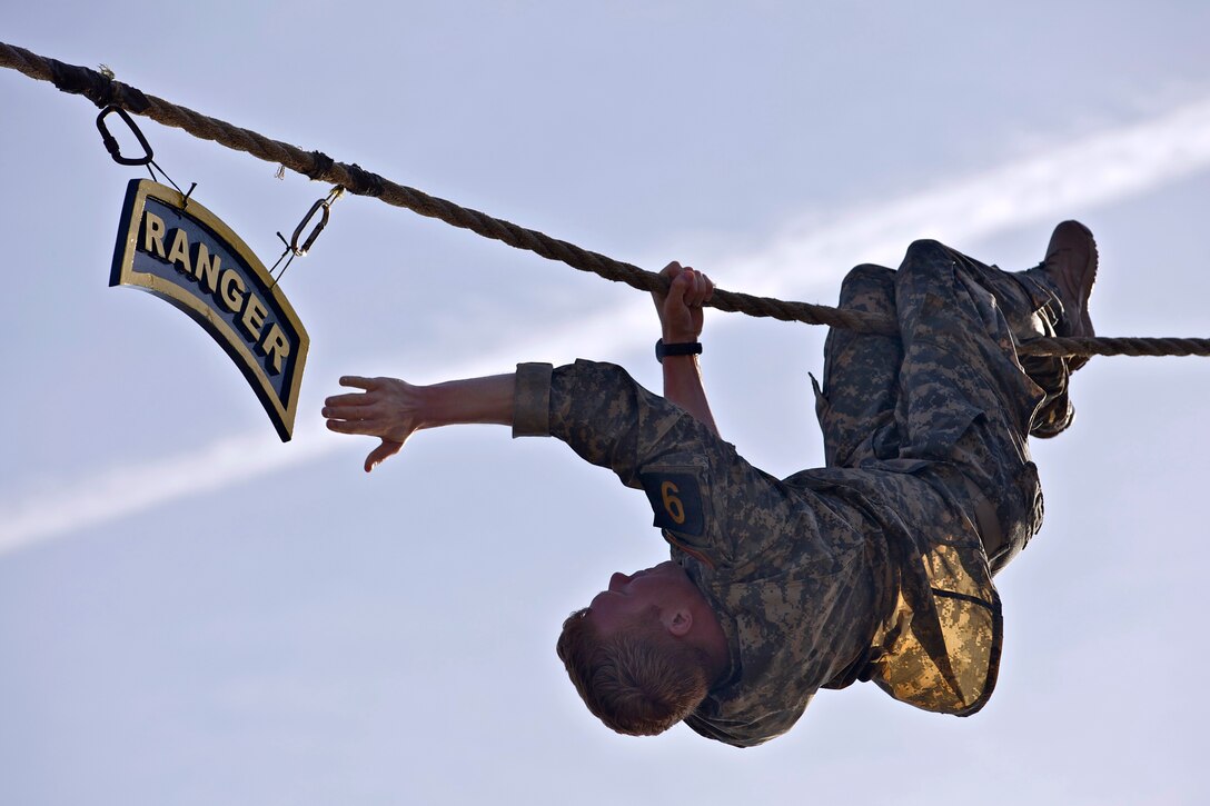 Army 1st Lt. Shaun Looney reaches for the ranger sign while hanging off ...