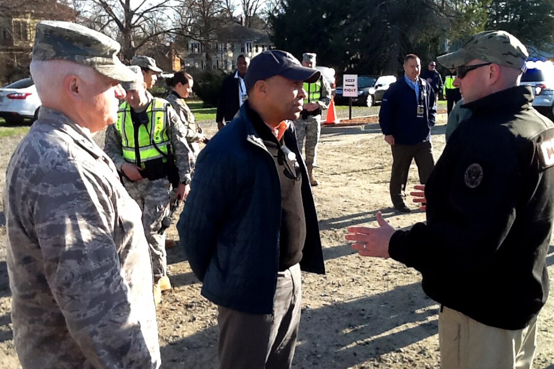 Air Force Lt. Col. Matthew Woolums, right, briefs Massachusetts Gov ...