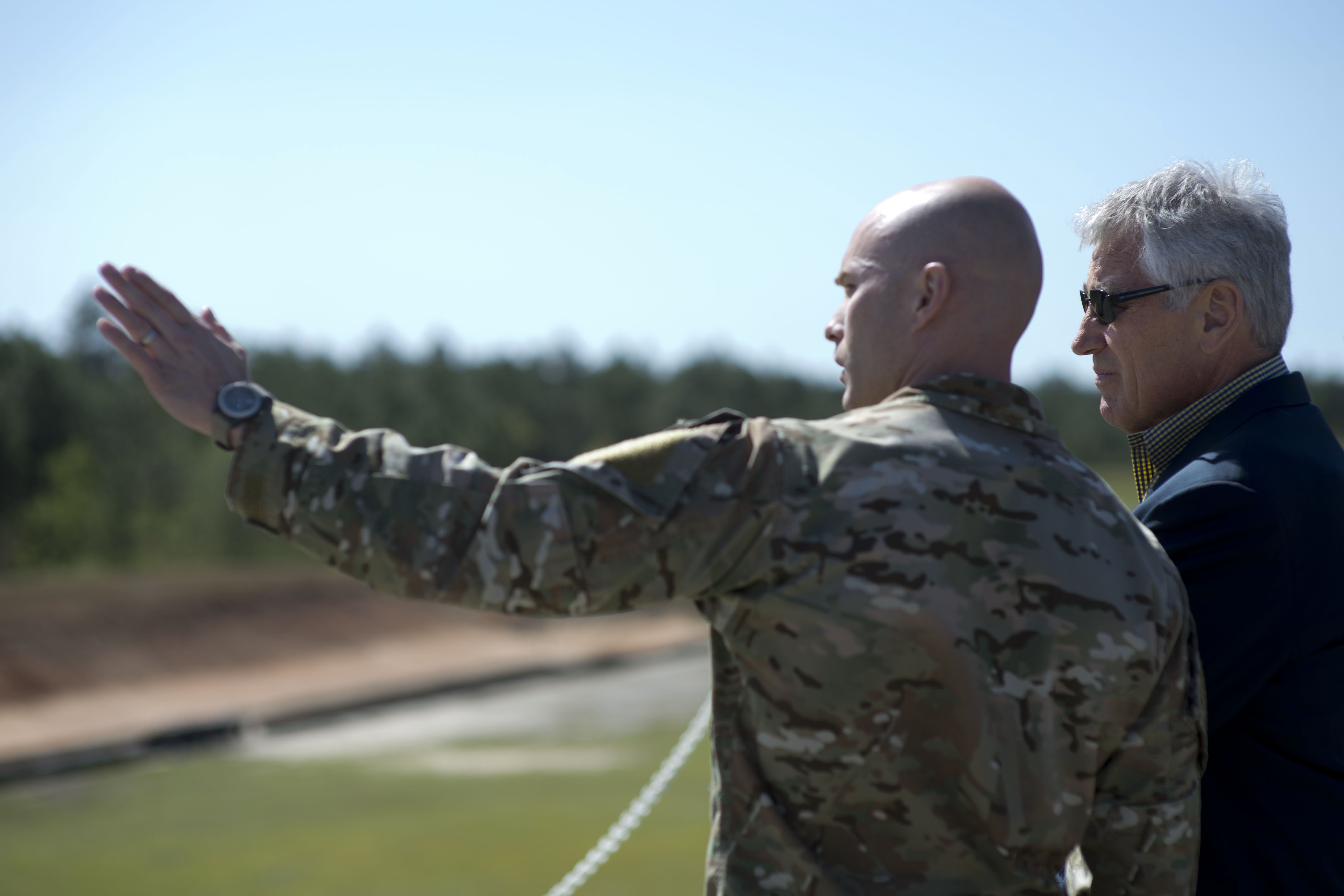 Defense Secretary Chuck Hagel watches a demonstration while touring a ...