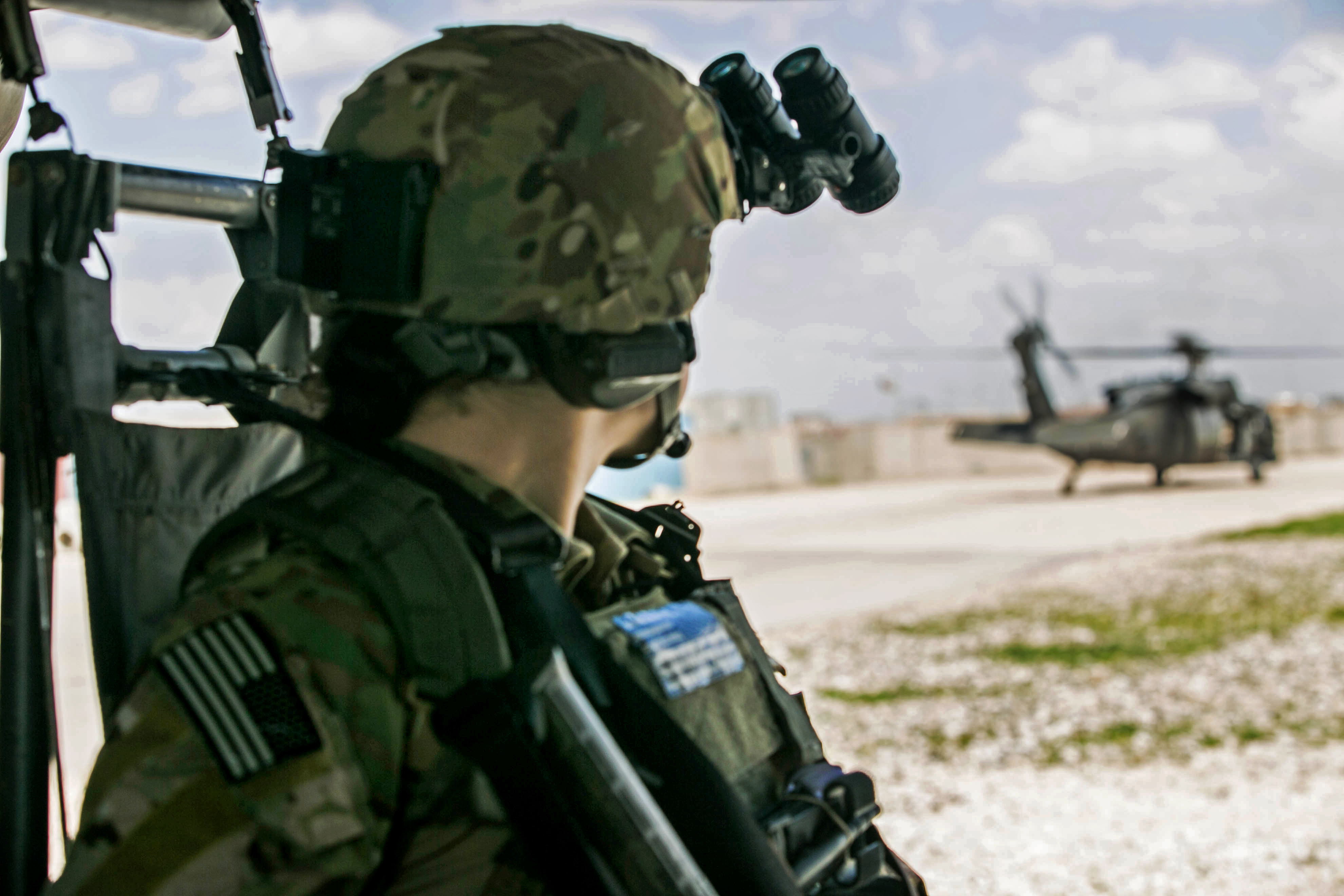 A U.S. soldier waits to take off in a UH-60 Black Hawk helicopter for a ...