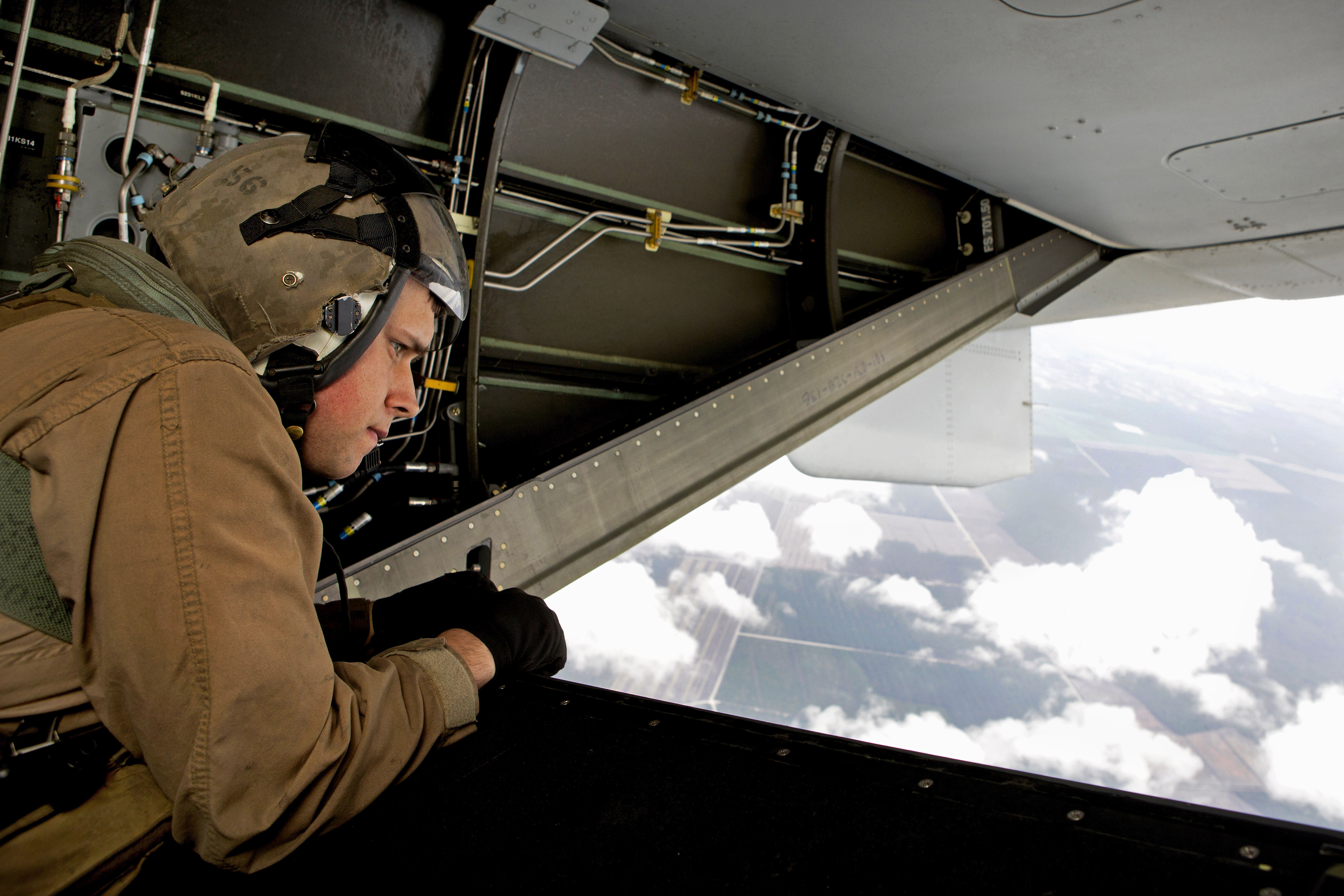Marine Corps Sgt. Robert M. Howard looks out the back ramp of an MV-22 ...