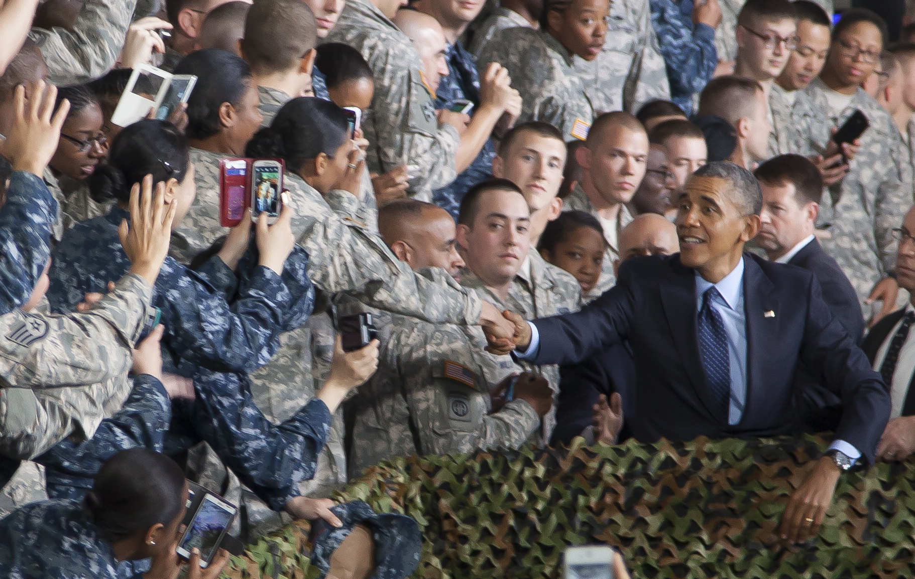 U.S. President Barack Obama shakes hands with a soldier after speaking ...