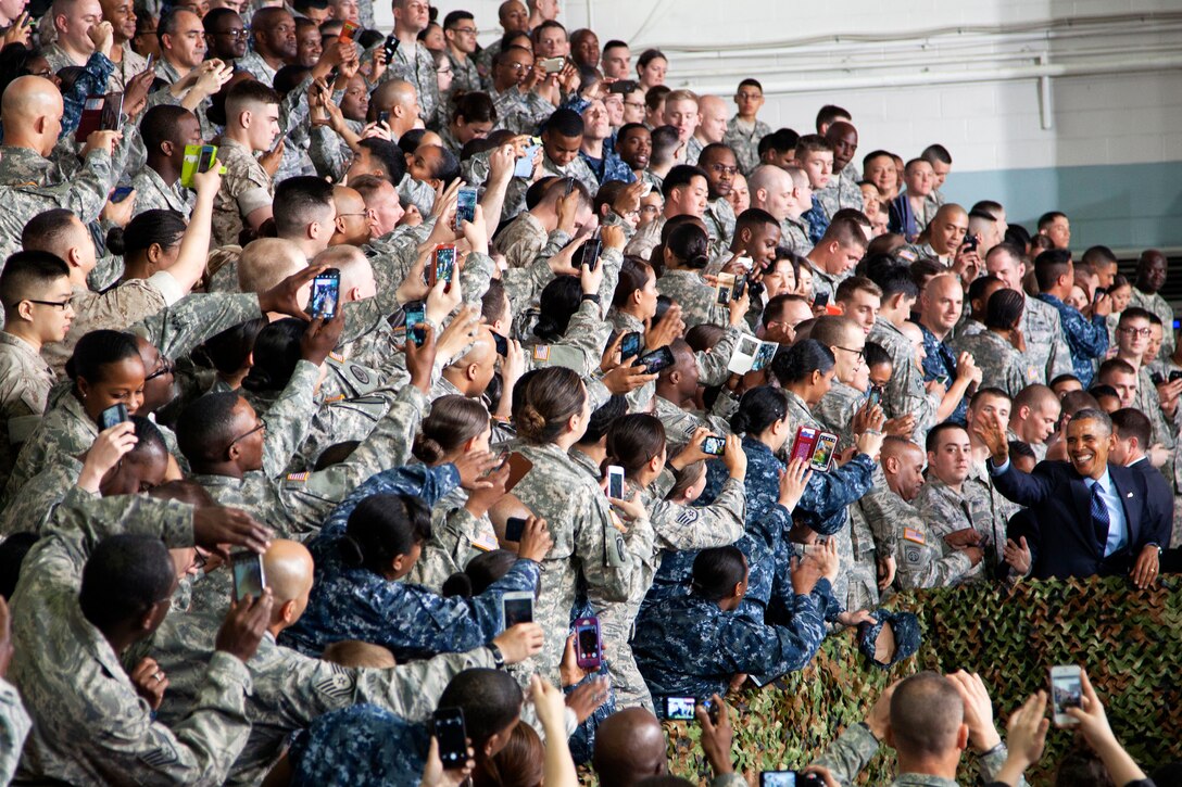 U.S. service members rush to get a final photograph of U.S. President ...