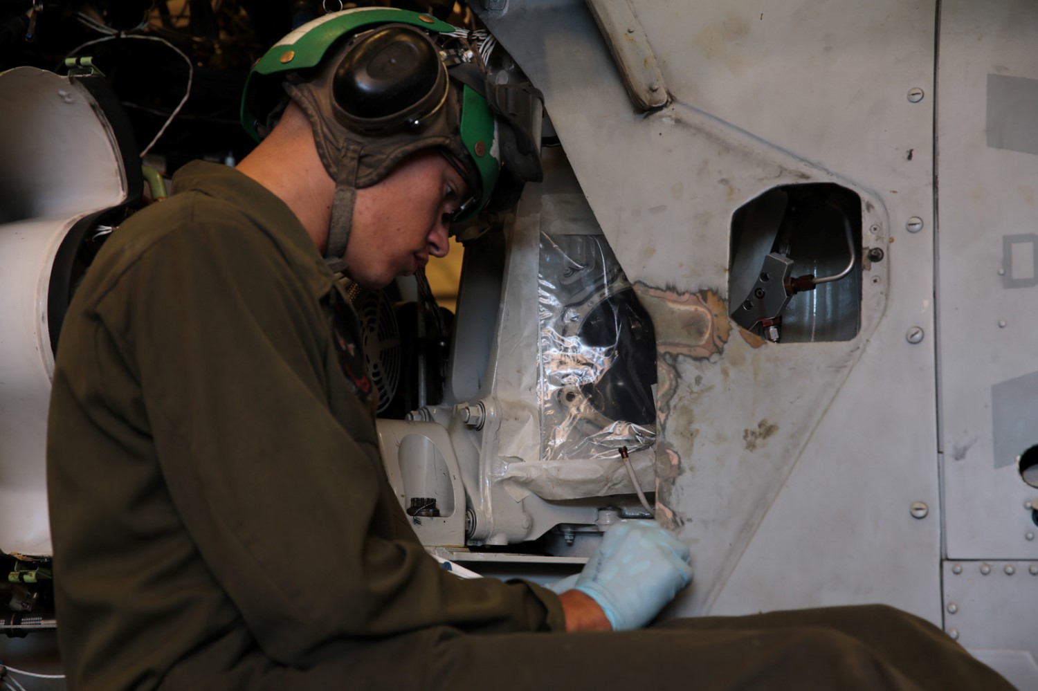 Marines and sailors perform maintenance underway