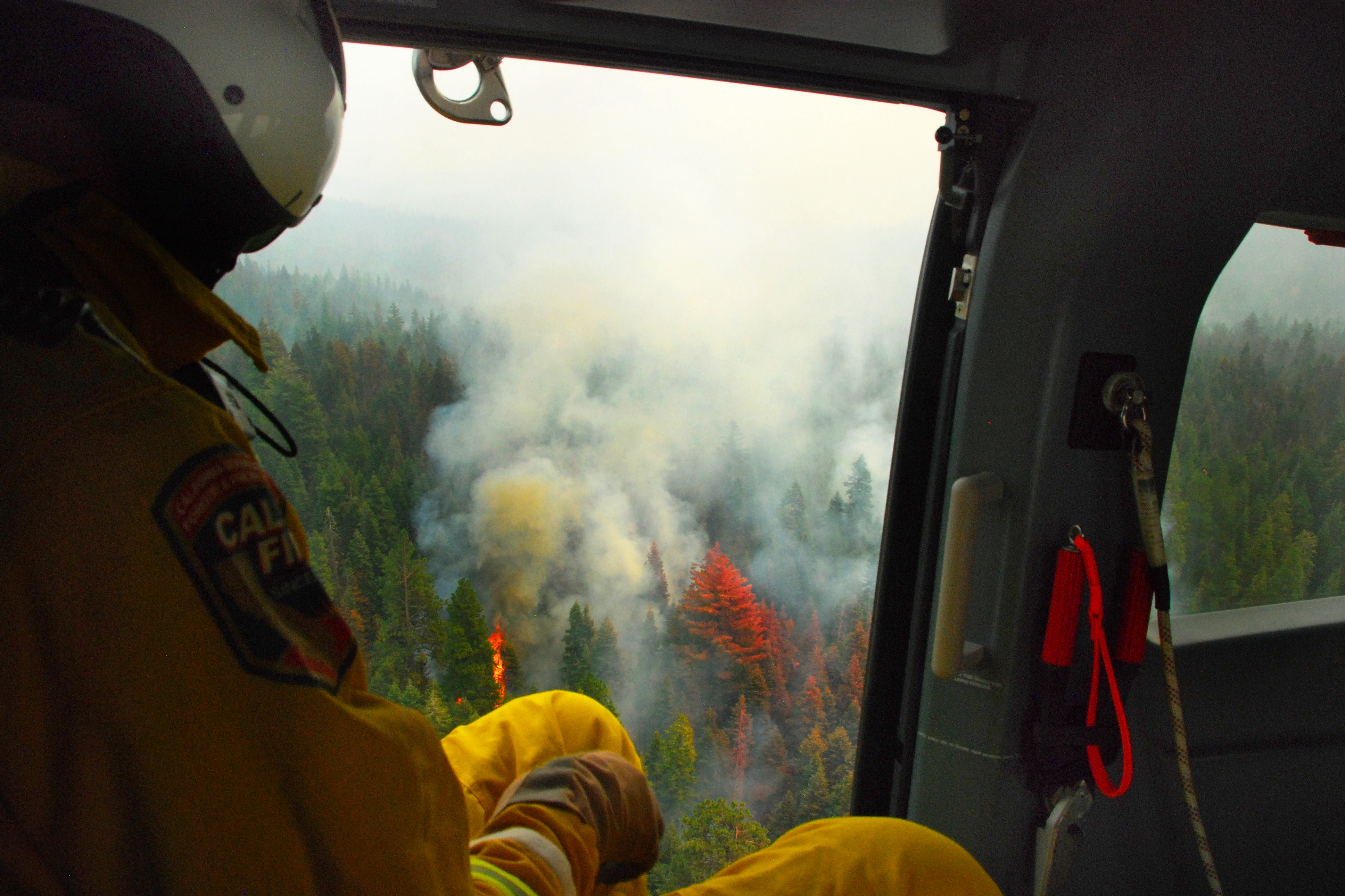 California Fire Manager Bob Innes observes a wildfire near Fall River ...