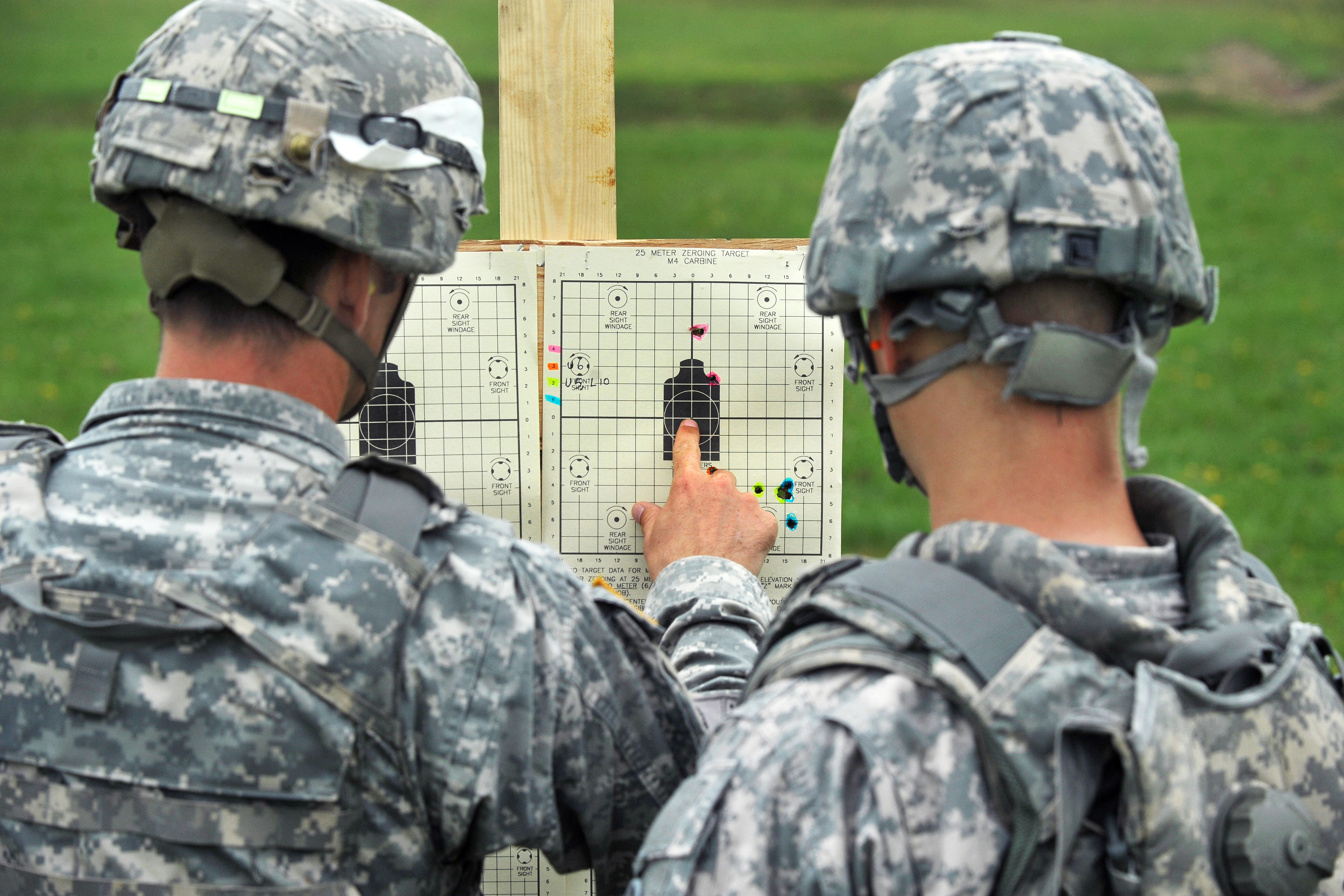 U.S. soldiers look at a target during M4 carbine rifle qualification on ...