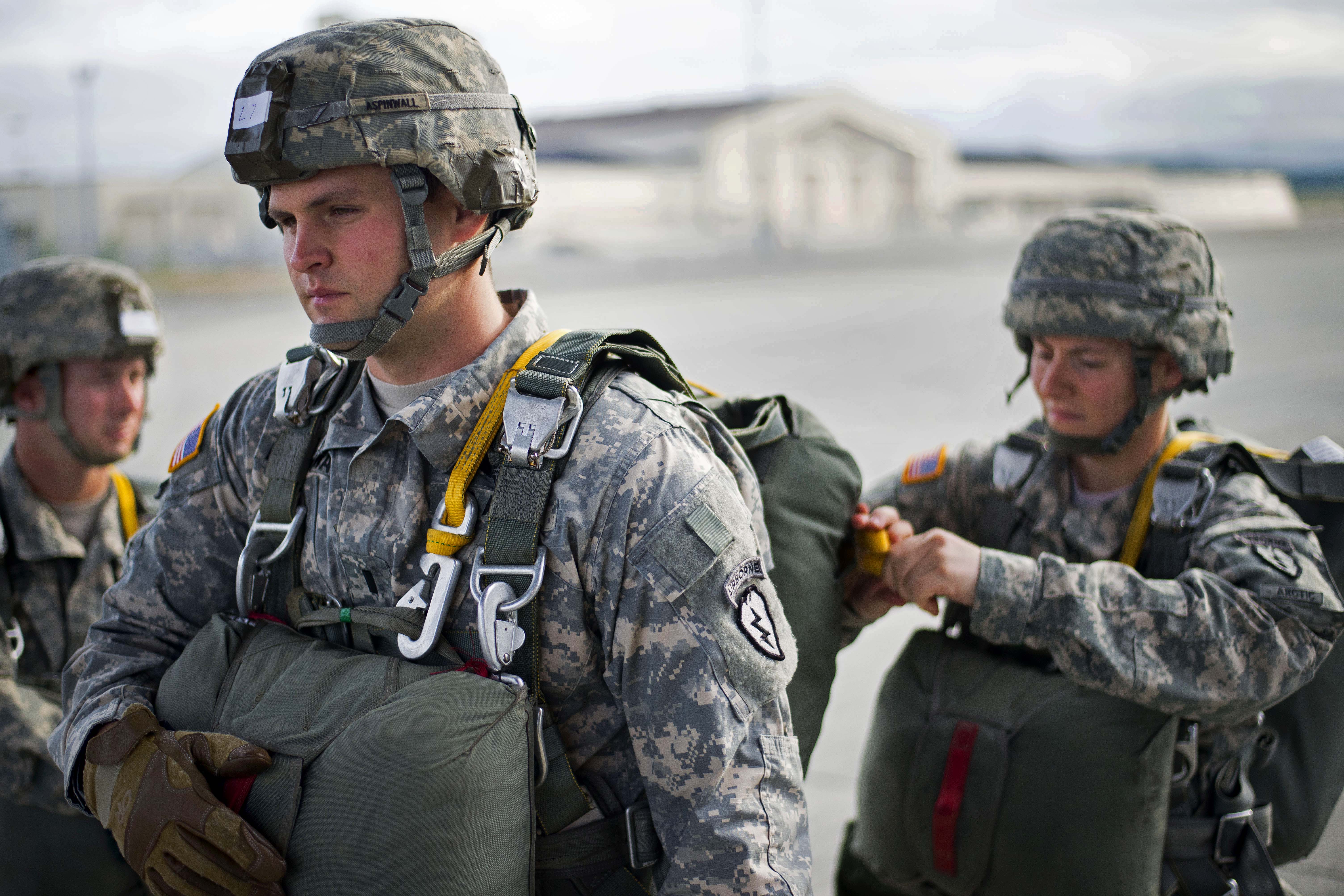 An Army jumpmaster, right, inspects paratroopers’ parachutes before ...