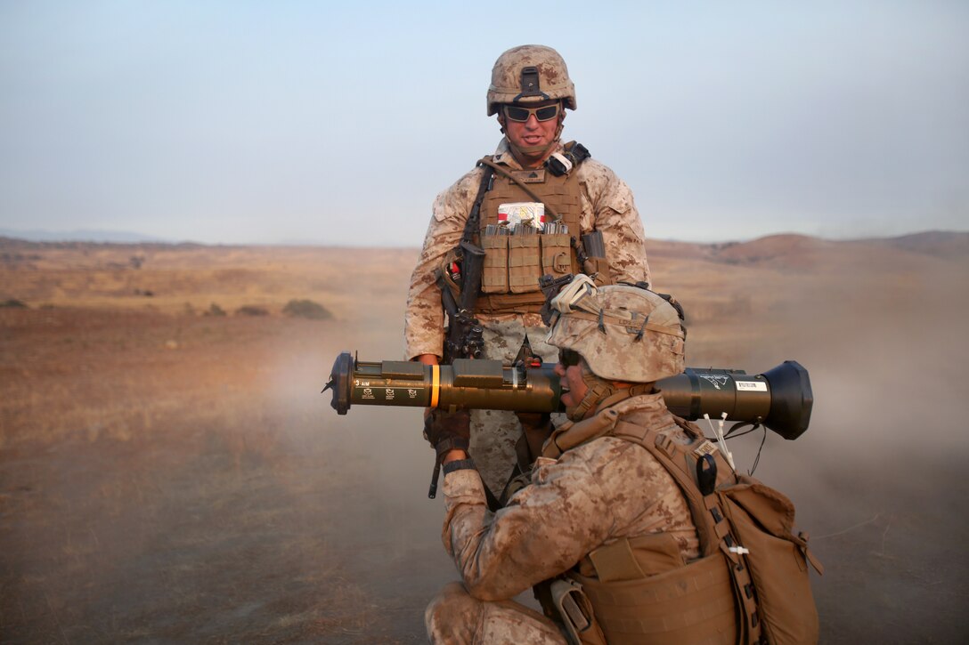 Marine Corps Lance Cpl. Jacob Dehose, foreground, reacts after firing ...