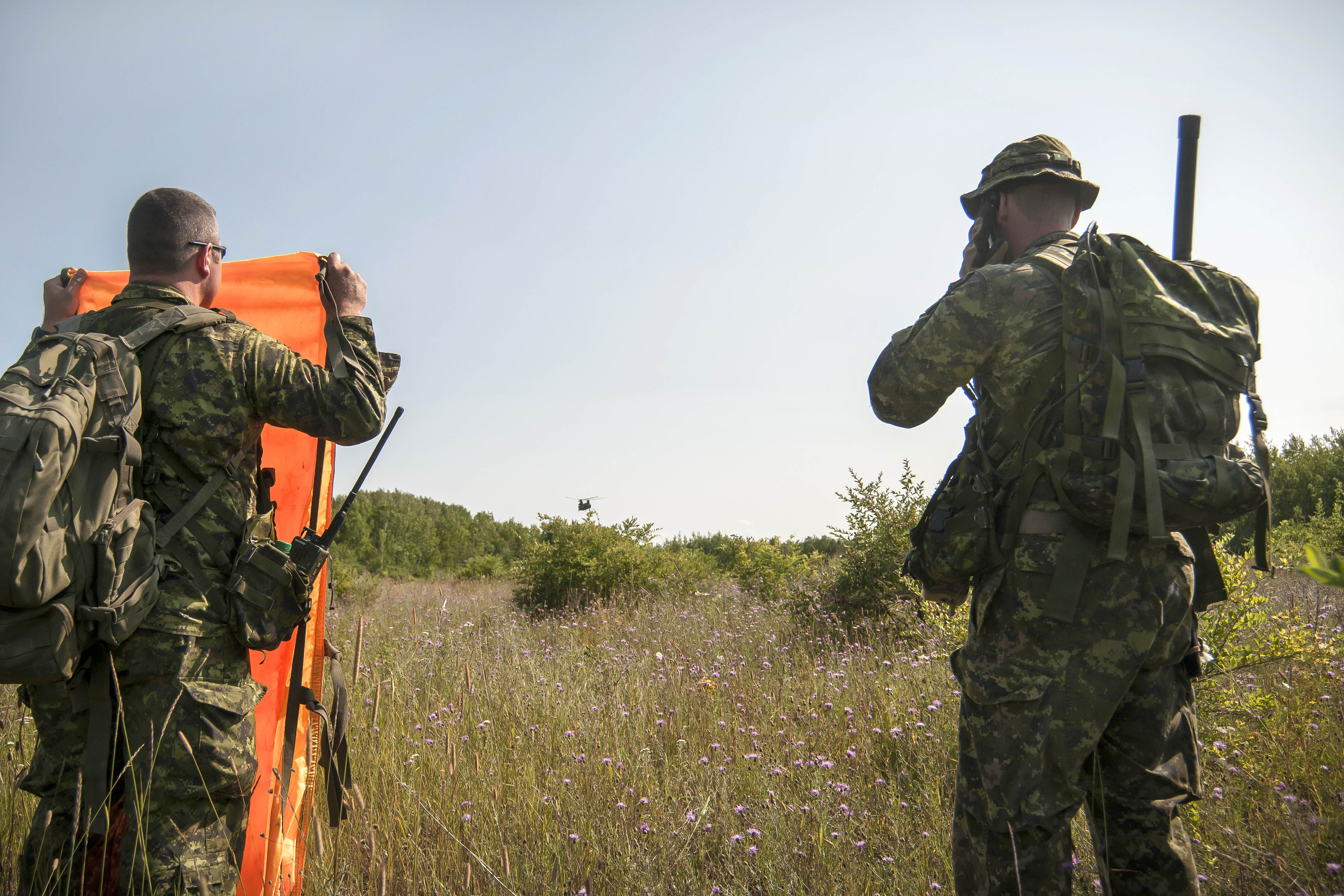 Canadian Air Force Capt. Alan Lockerby, left, communicates with a CH-47 ...