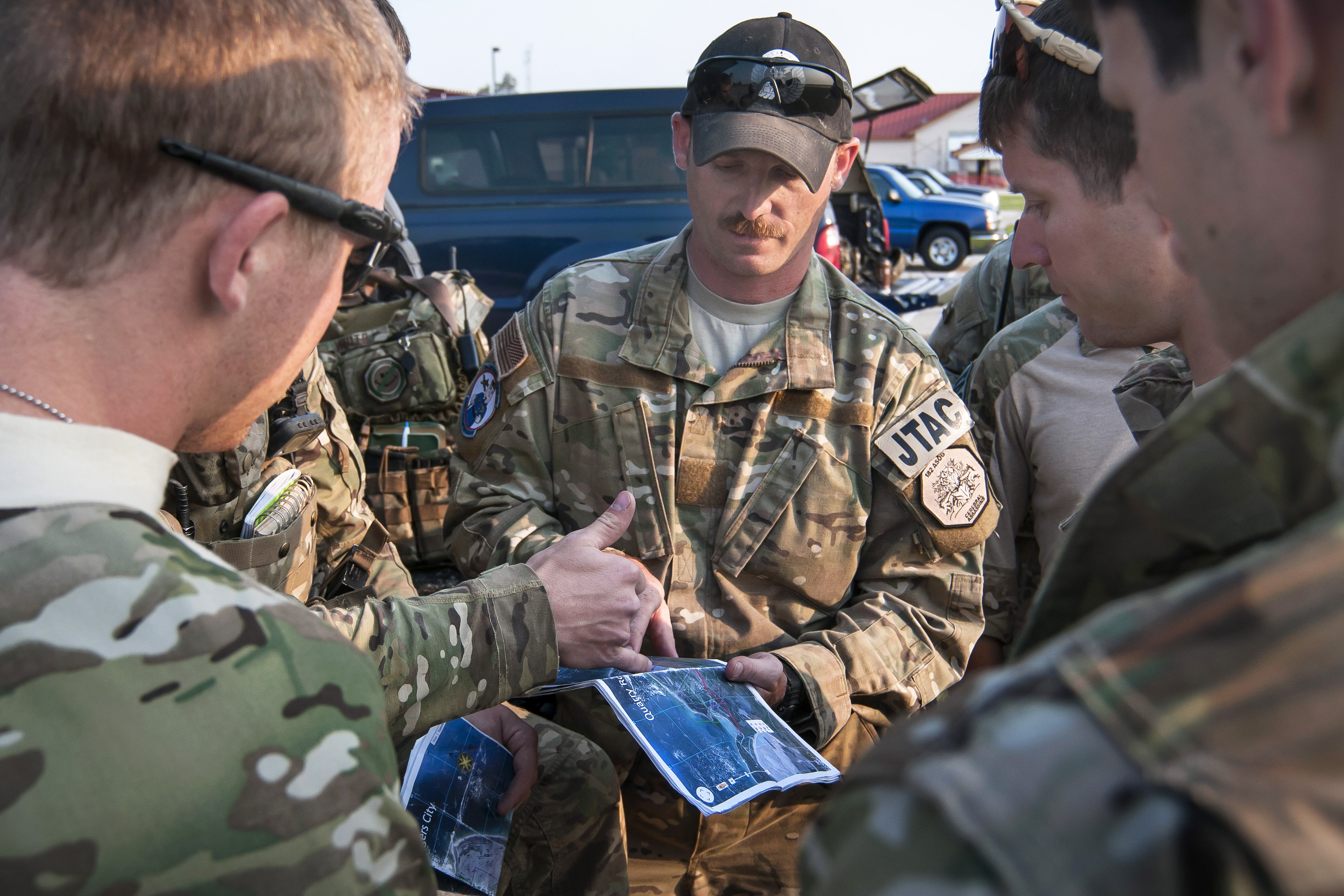 U.S. Air Force Master Sgt. Lionel Gillis, center, explains a mission to ...