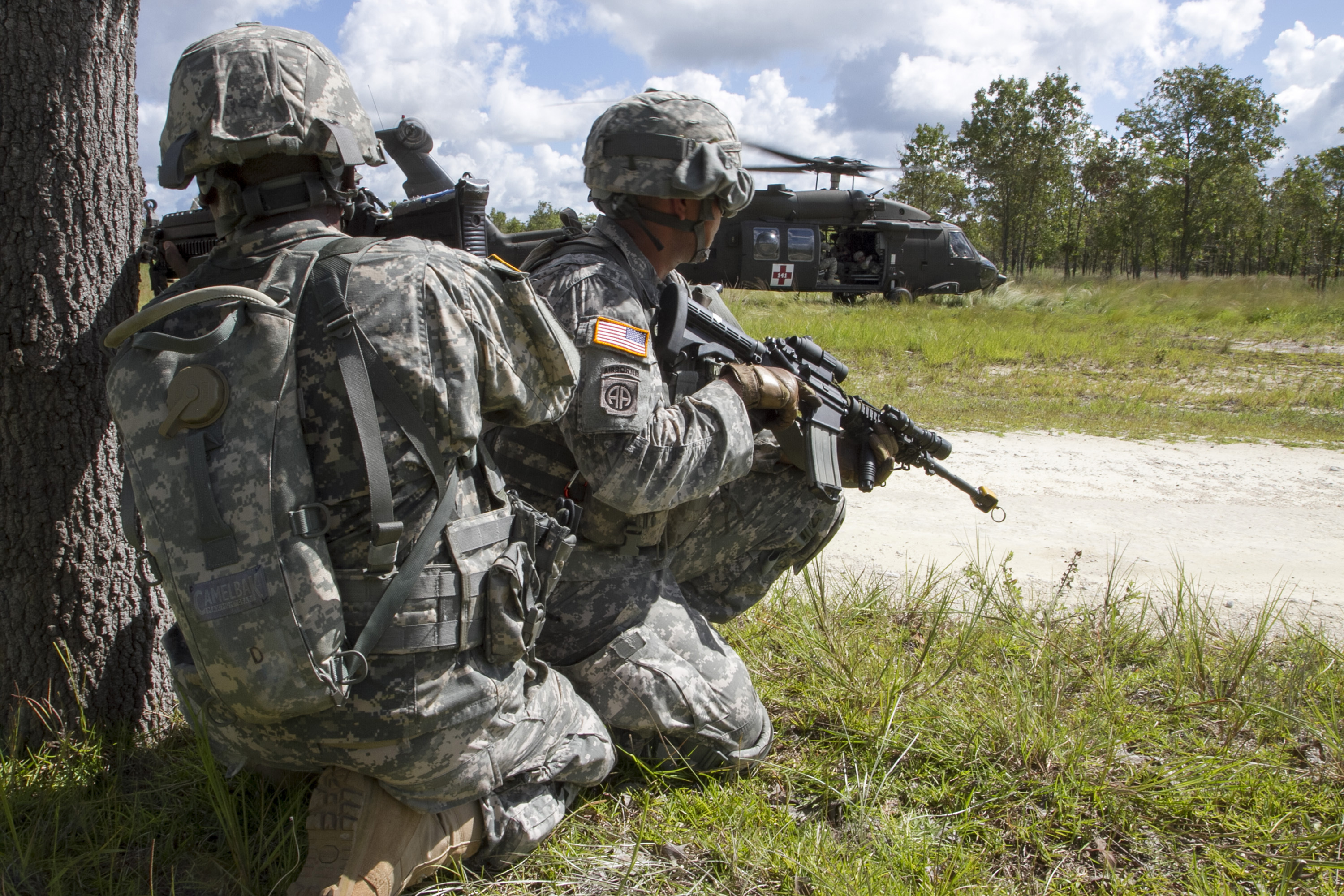 Army Spc. Michael Edwards, right, provides security while soldiers load ...