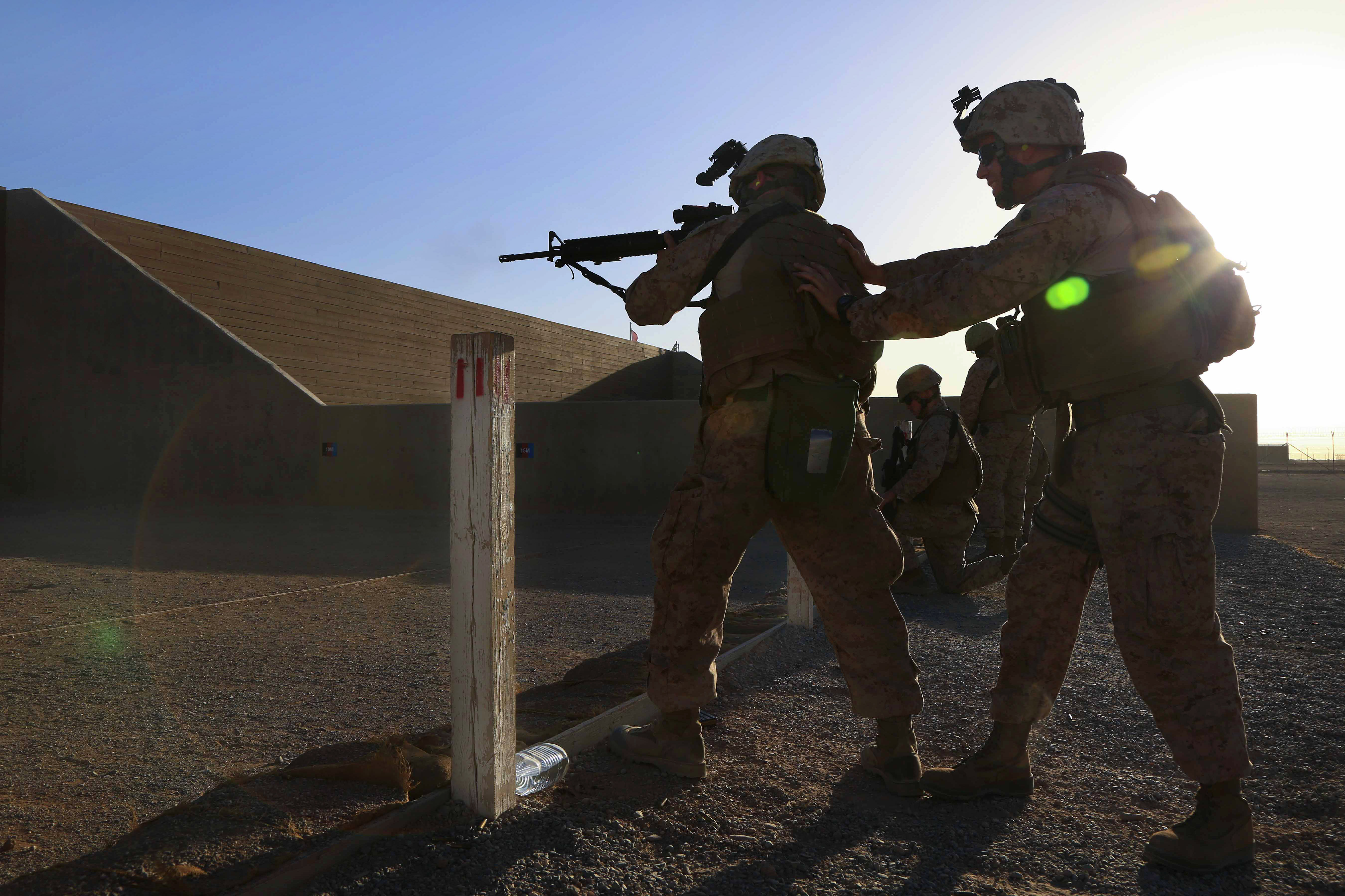 U.S. Marine Gunnery Sgt. Cody G. Gormley, right, supports a Marine as ...