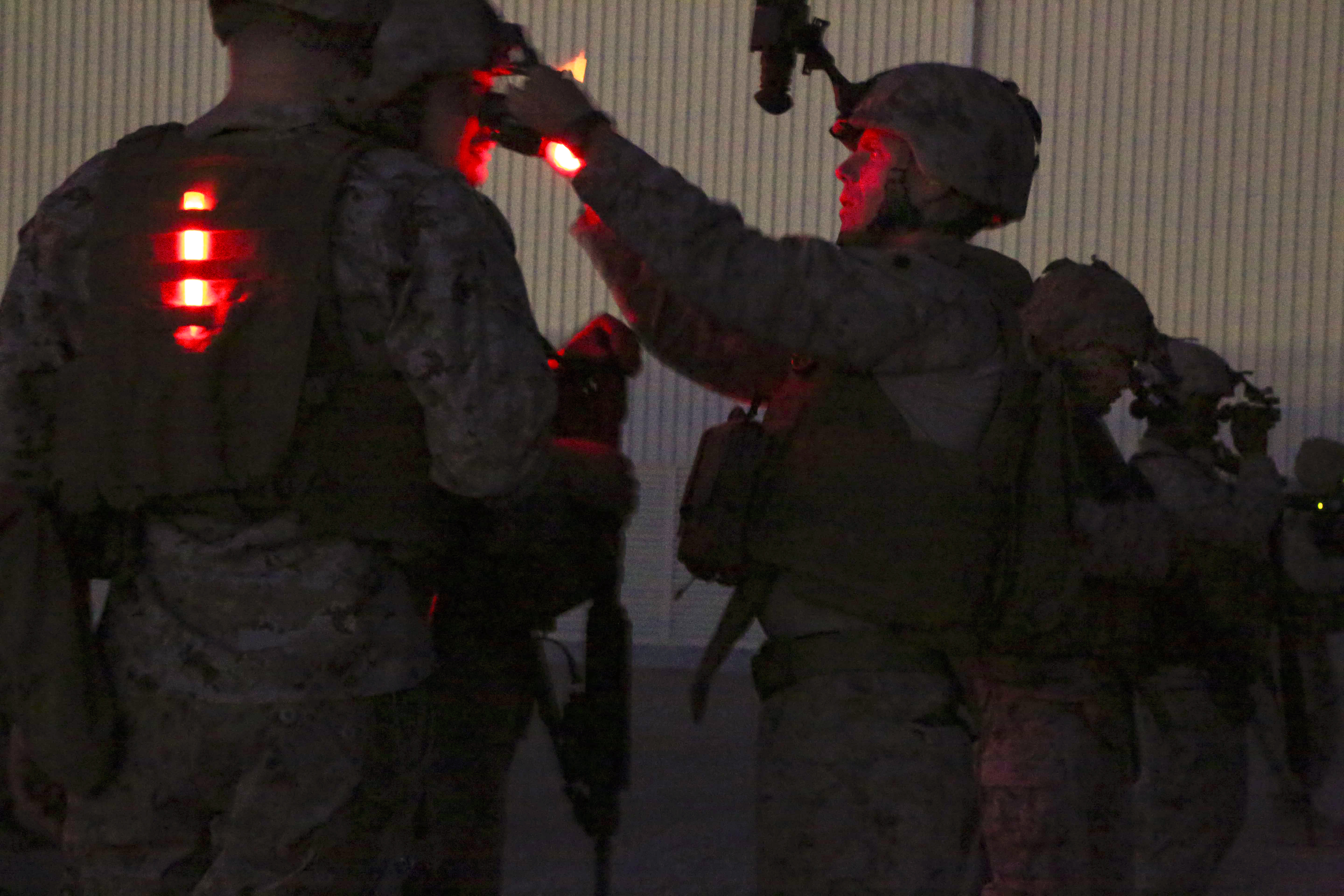 U.S. Marine Gunnery Sgt. Cody G. Gormley, right, adjusts a U.S. Marine ...