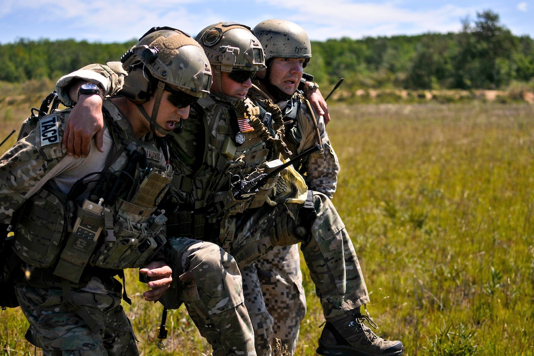 U.S. Air Force Senior Airman Thomas Vamvakos, left, and Latvian Cpl ...