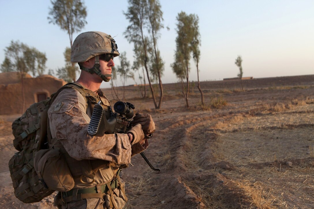 U.S. Marine Corps Cpl. Kevin Midgley provides security and looks for ...