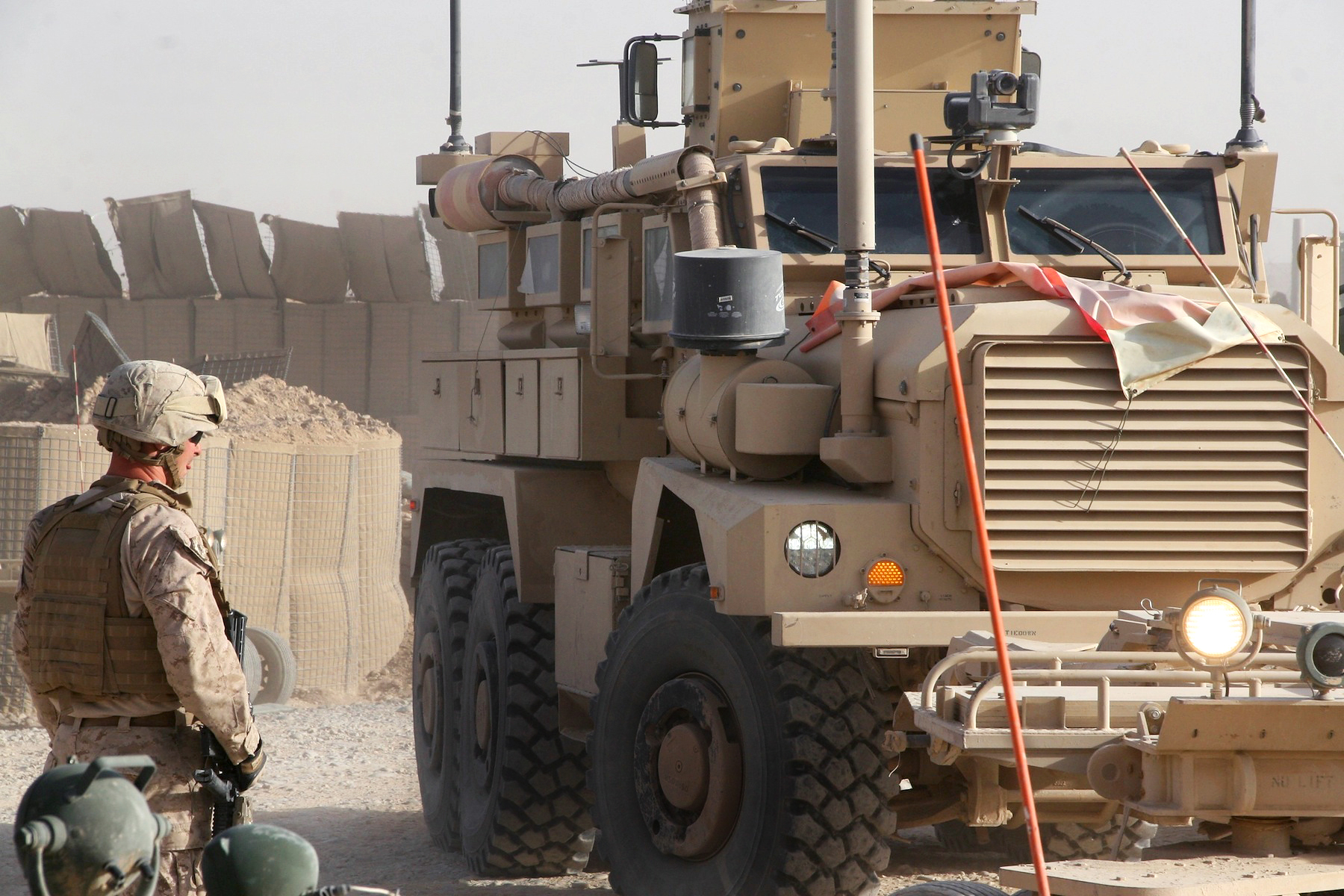 U.S. Marine guides the operator of a mine-resistant, ambush-protected ...