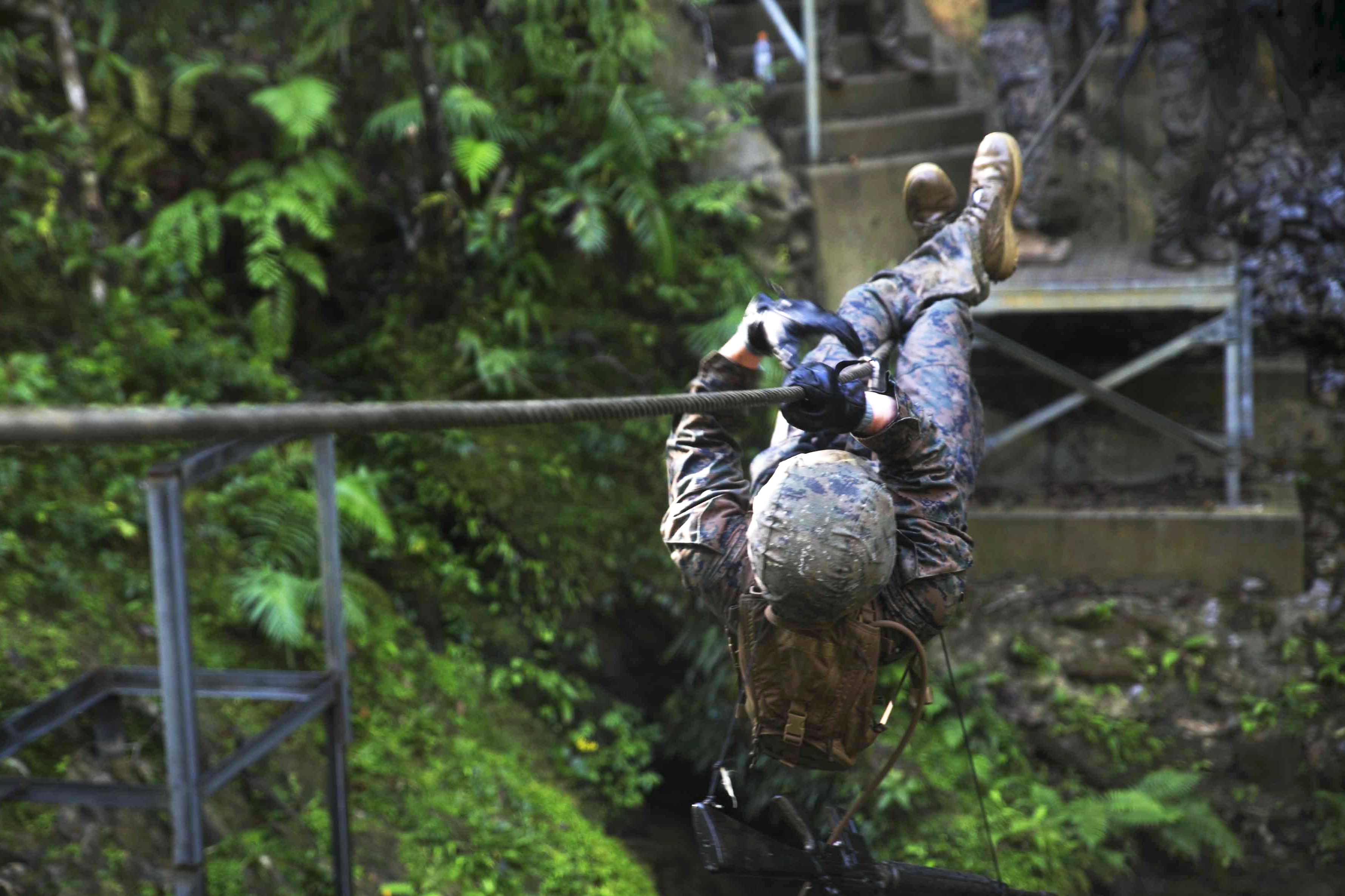 U.S. Marine Corps Cpl. Samuel C. Mills crosses a river obstacle while ...