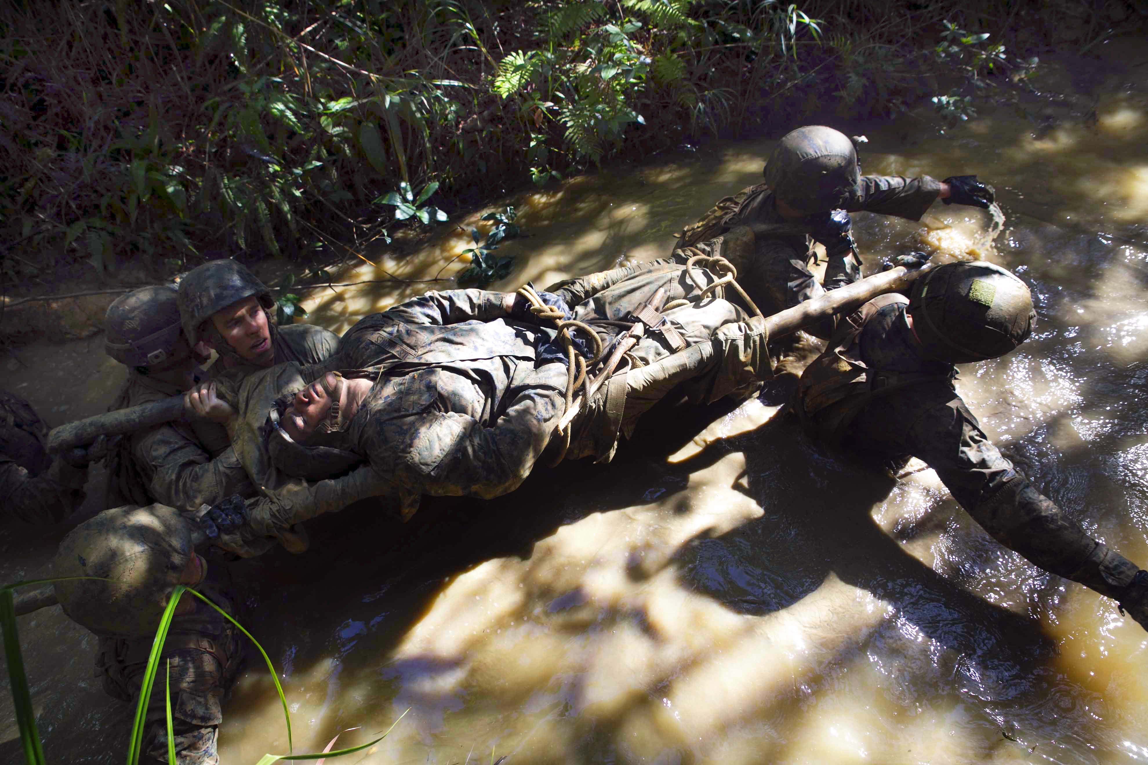 U.S. Marines carry a simulated casualty on an improvised litter while ...